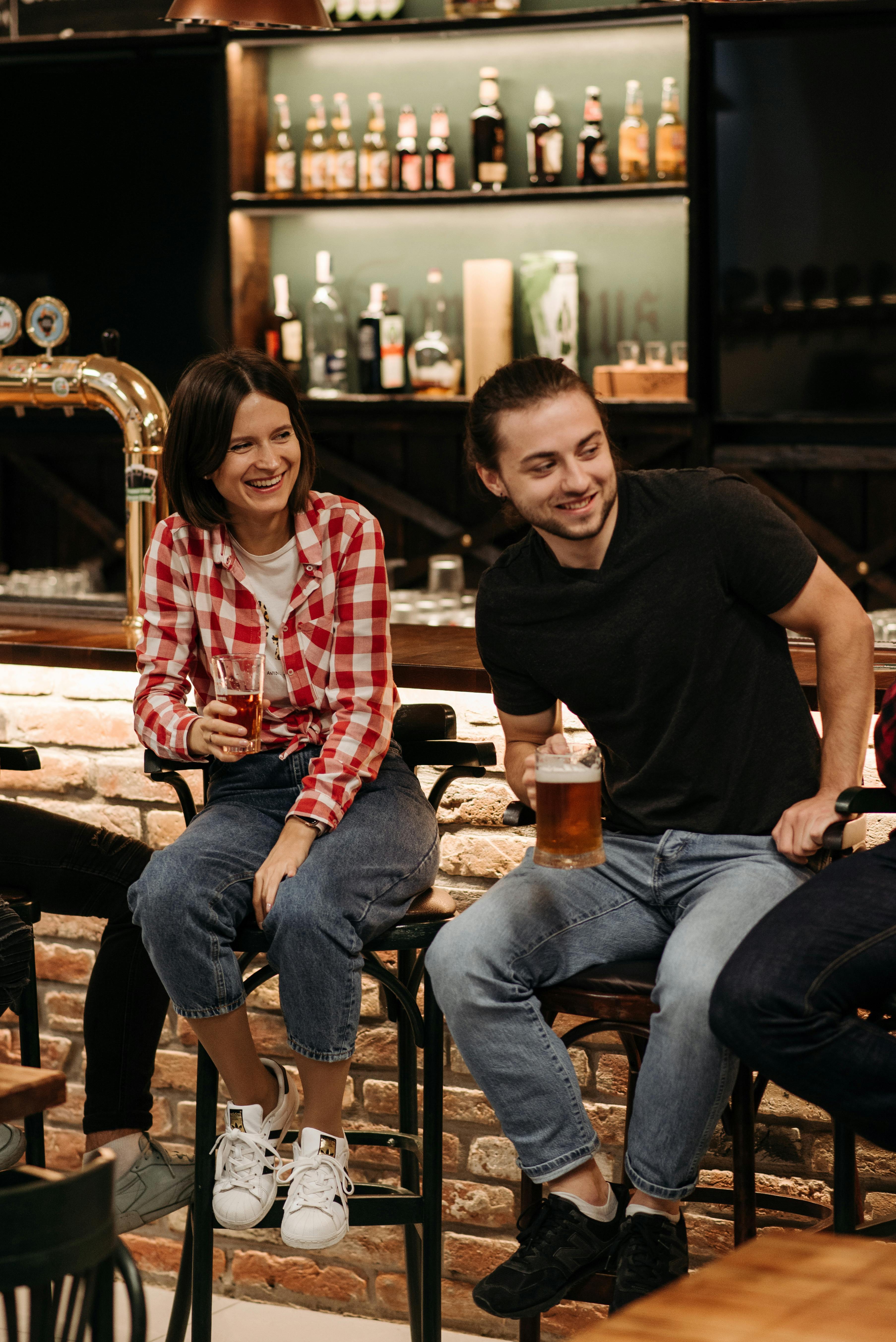 A Man in Black Crew Neck T-shirt Sitting on a Bar Stool · Free Stock Photo