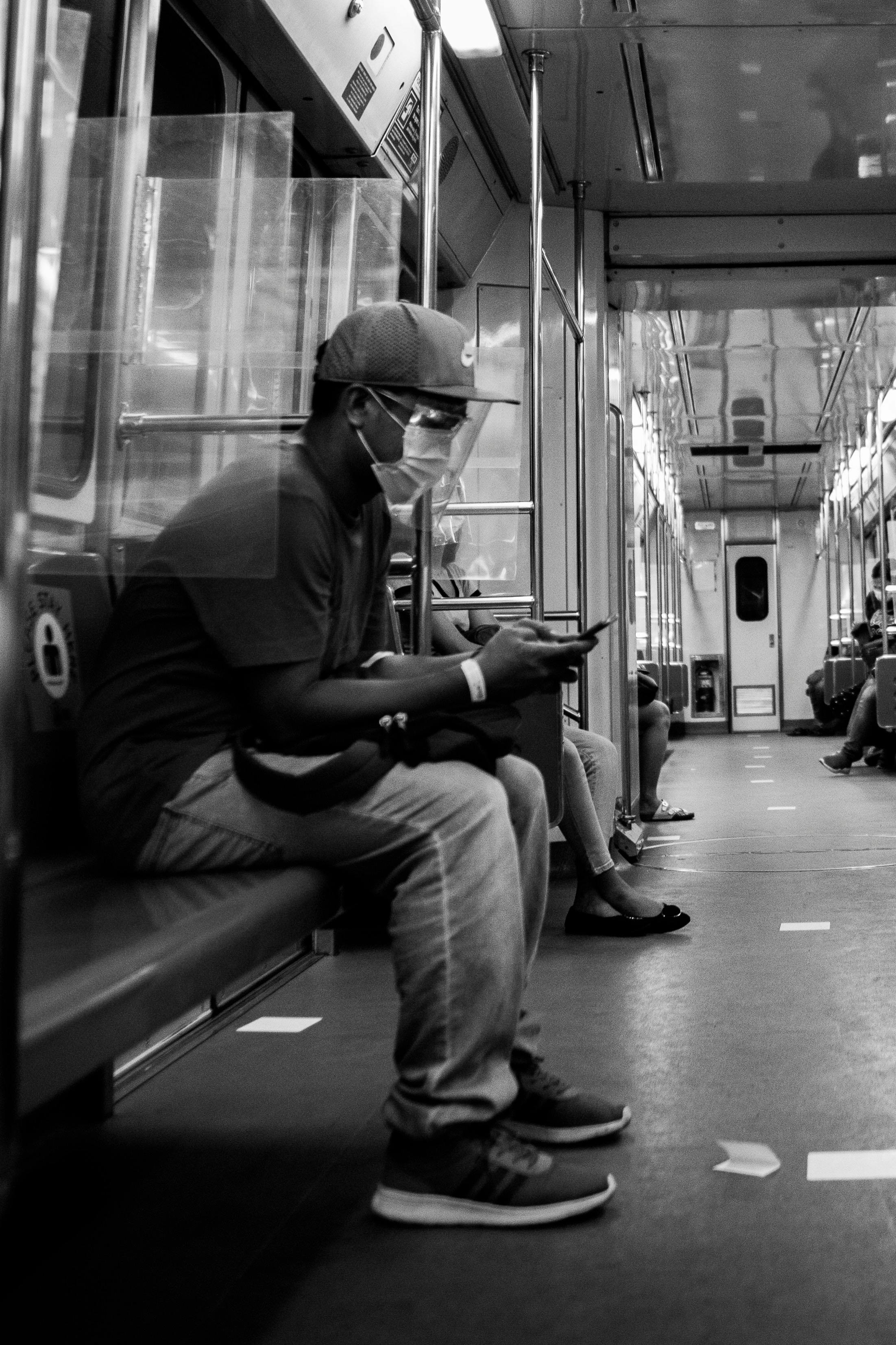 Grayscale Photo of People Inside Train · Free Stock Photo