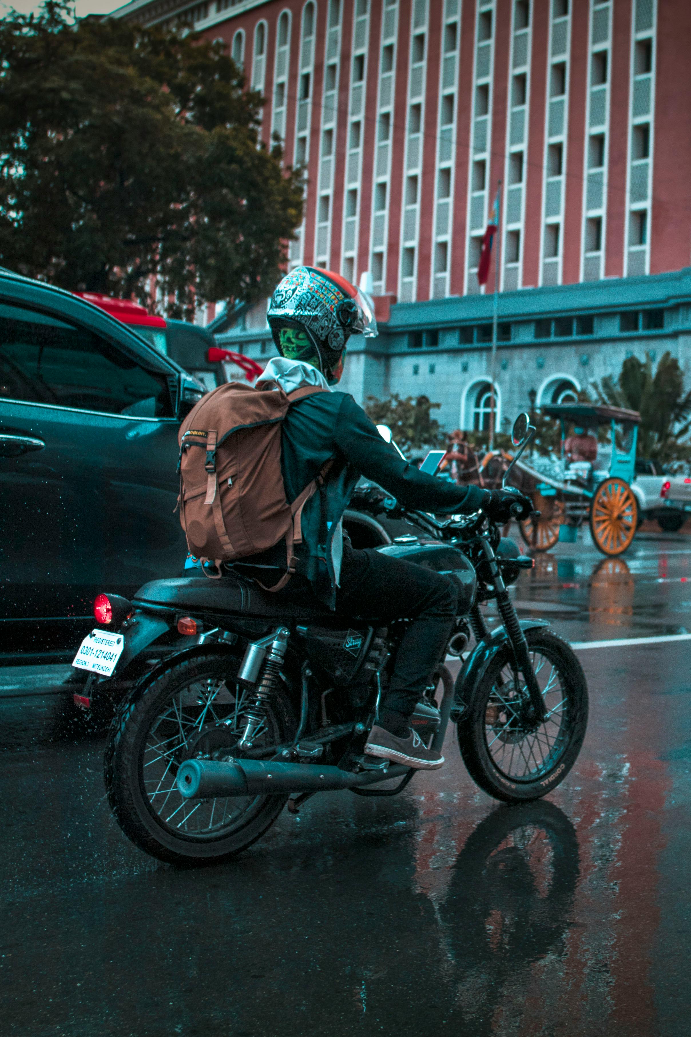 Photo of a Man with a Black Helmet Riding a Motorcycle · Free Stock Photo