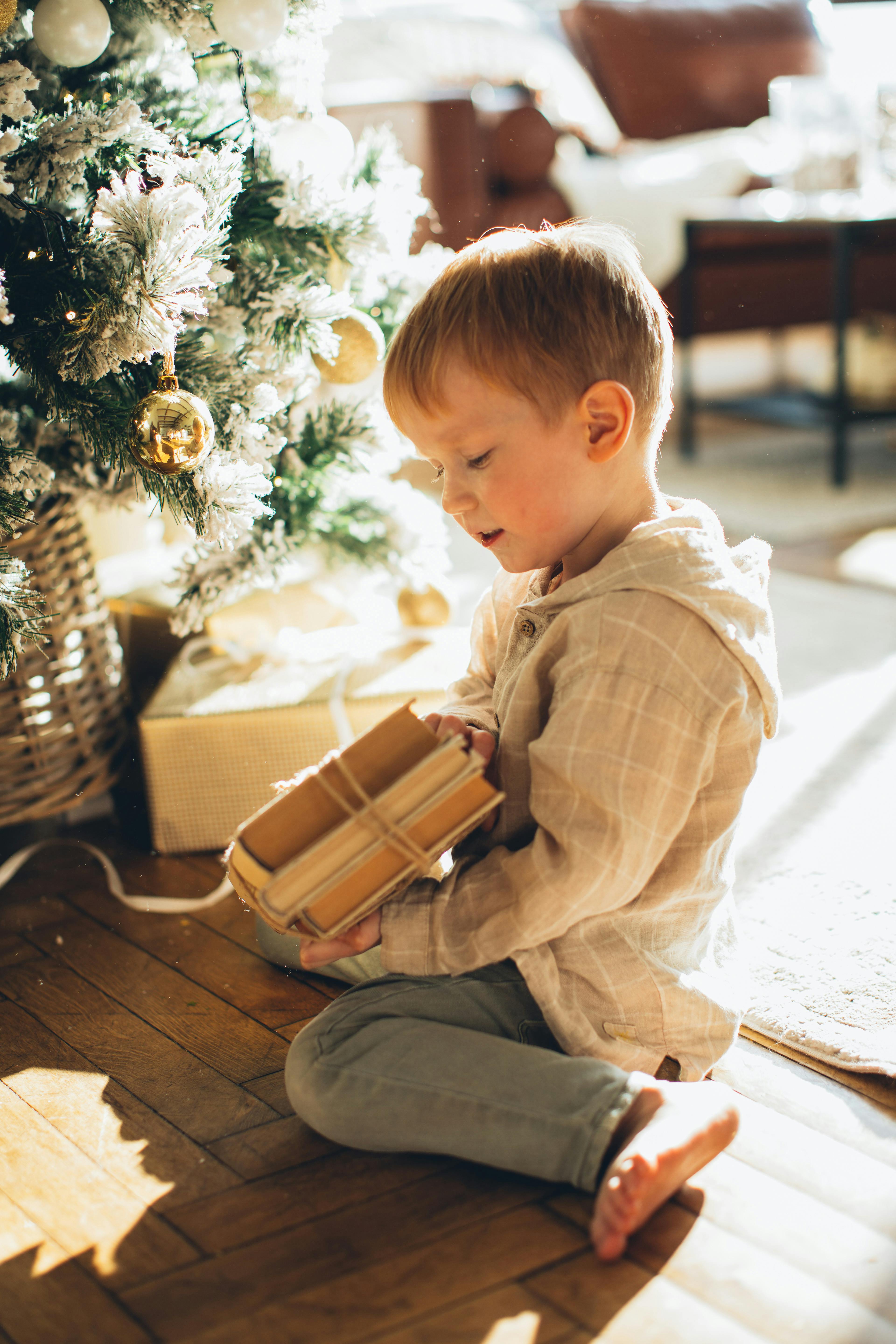 A Child Hugging Green and Yellow Book · Free Stock Photo
