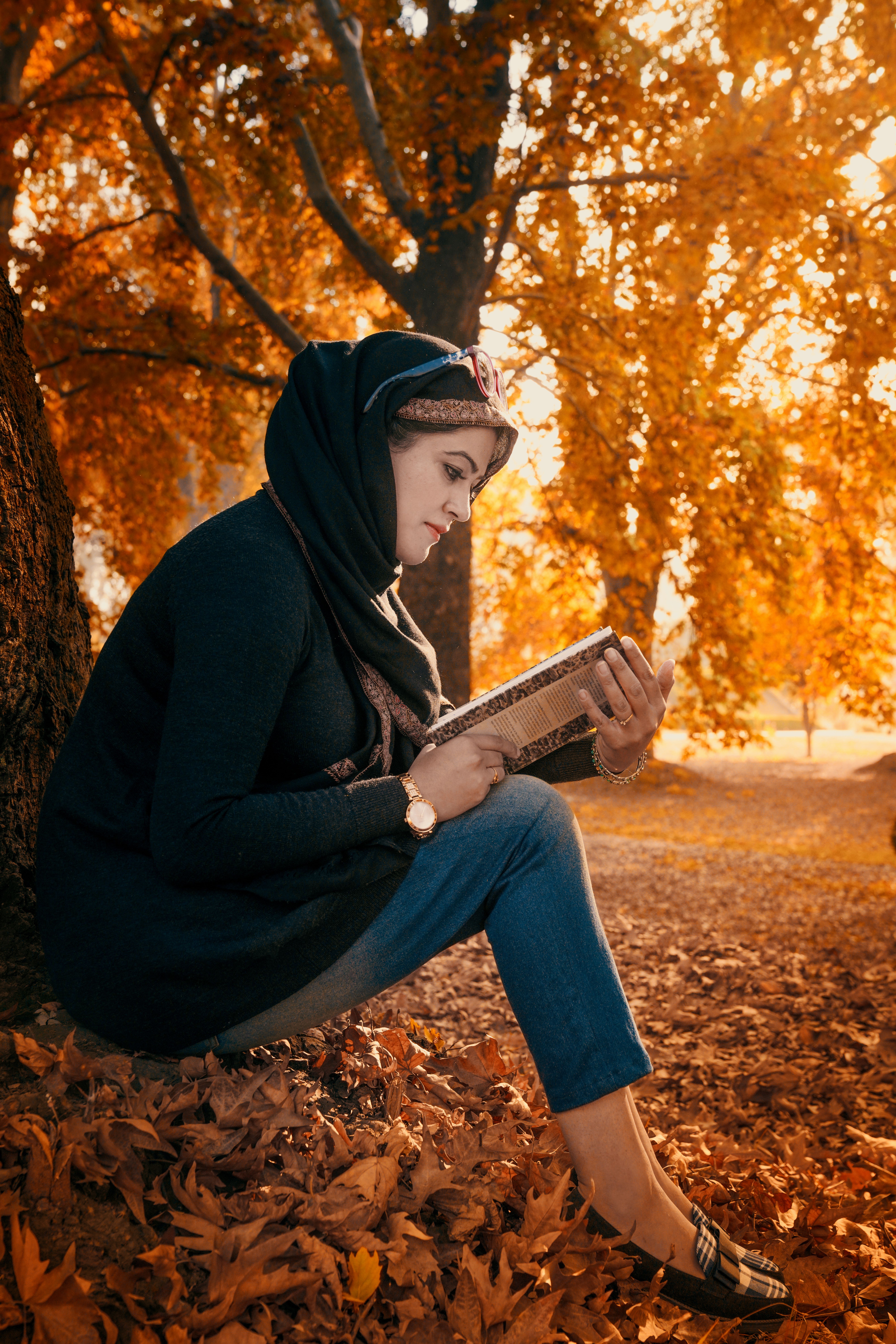 Woman Reading a Book Near a Tree · Free Stock Photo