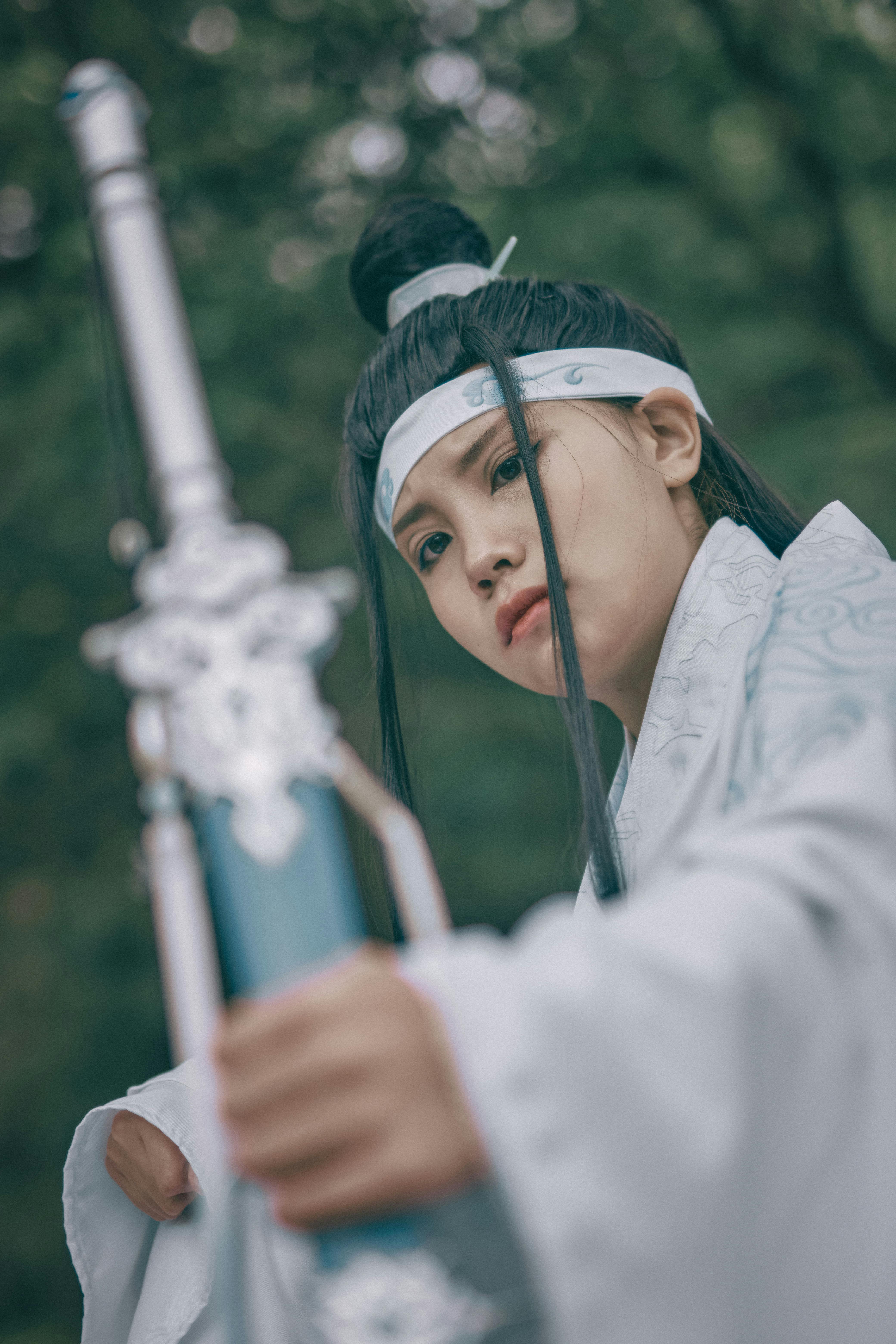 A Woman Unsheathing a Sword · Free Stock Photo