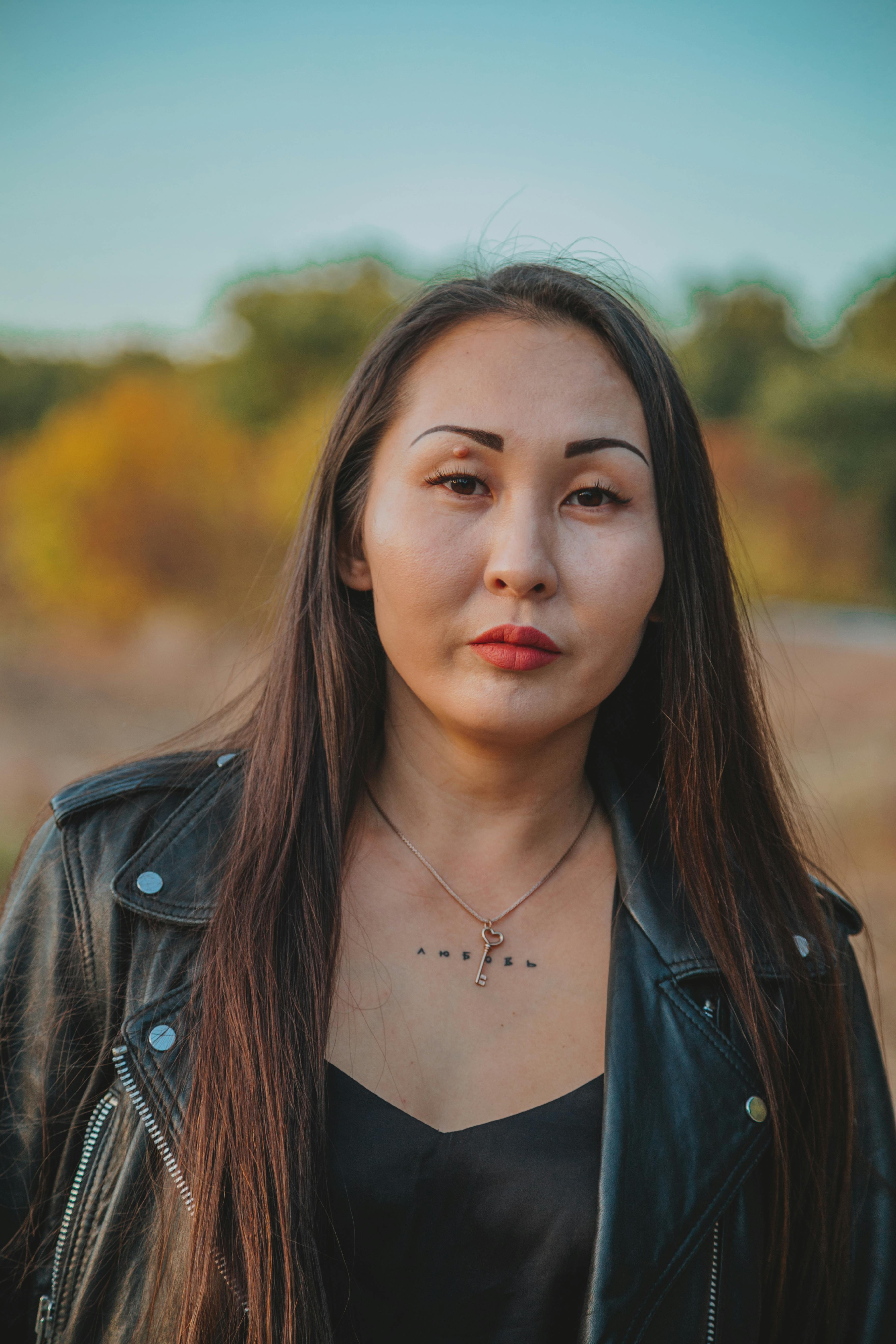 Stylish Asian woman standing in nature · Free Stock Photo