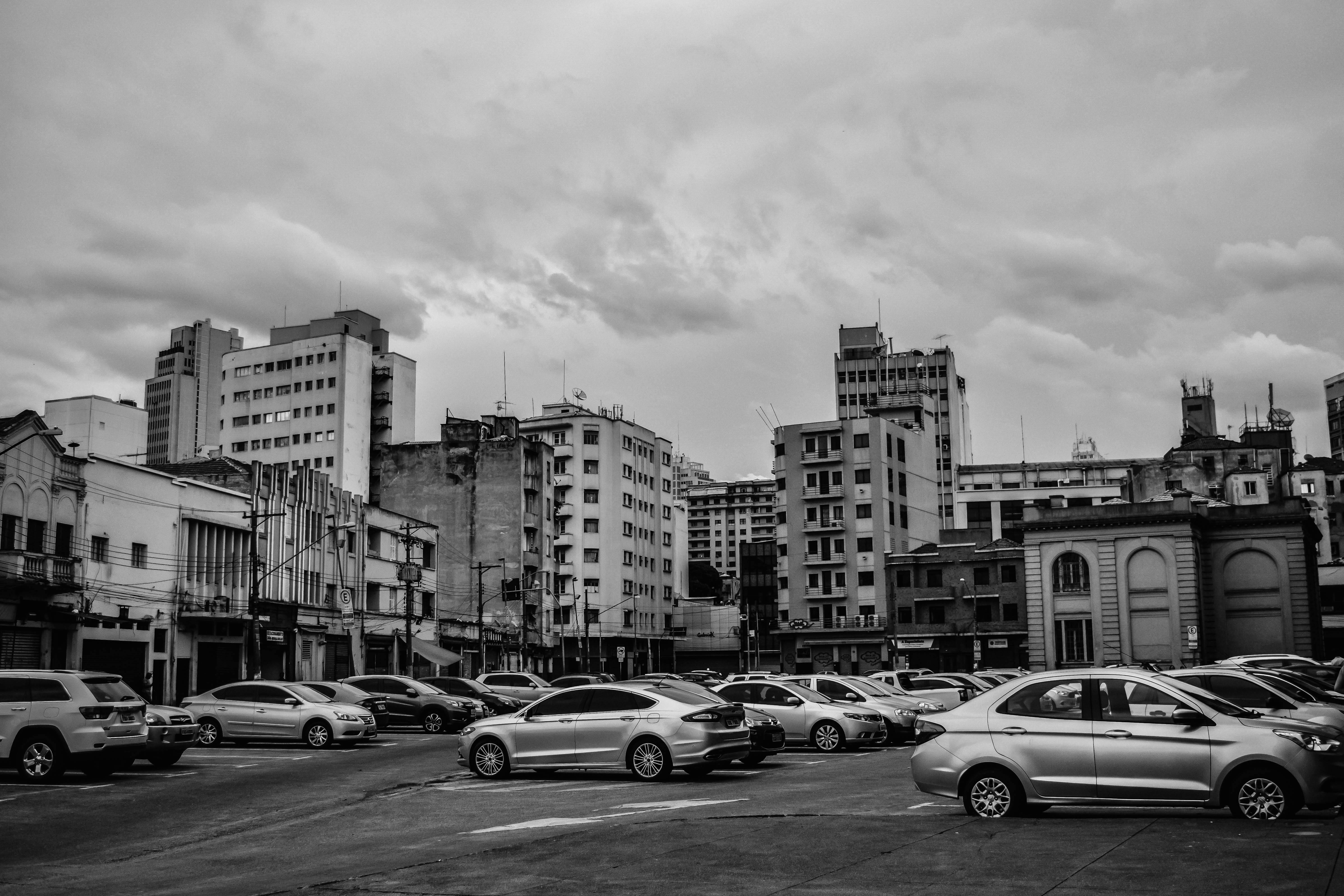 Grayscale Photo of Cars on Parking Area · Free Stock Photo