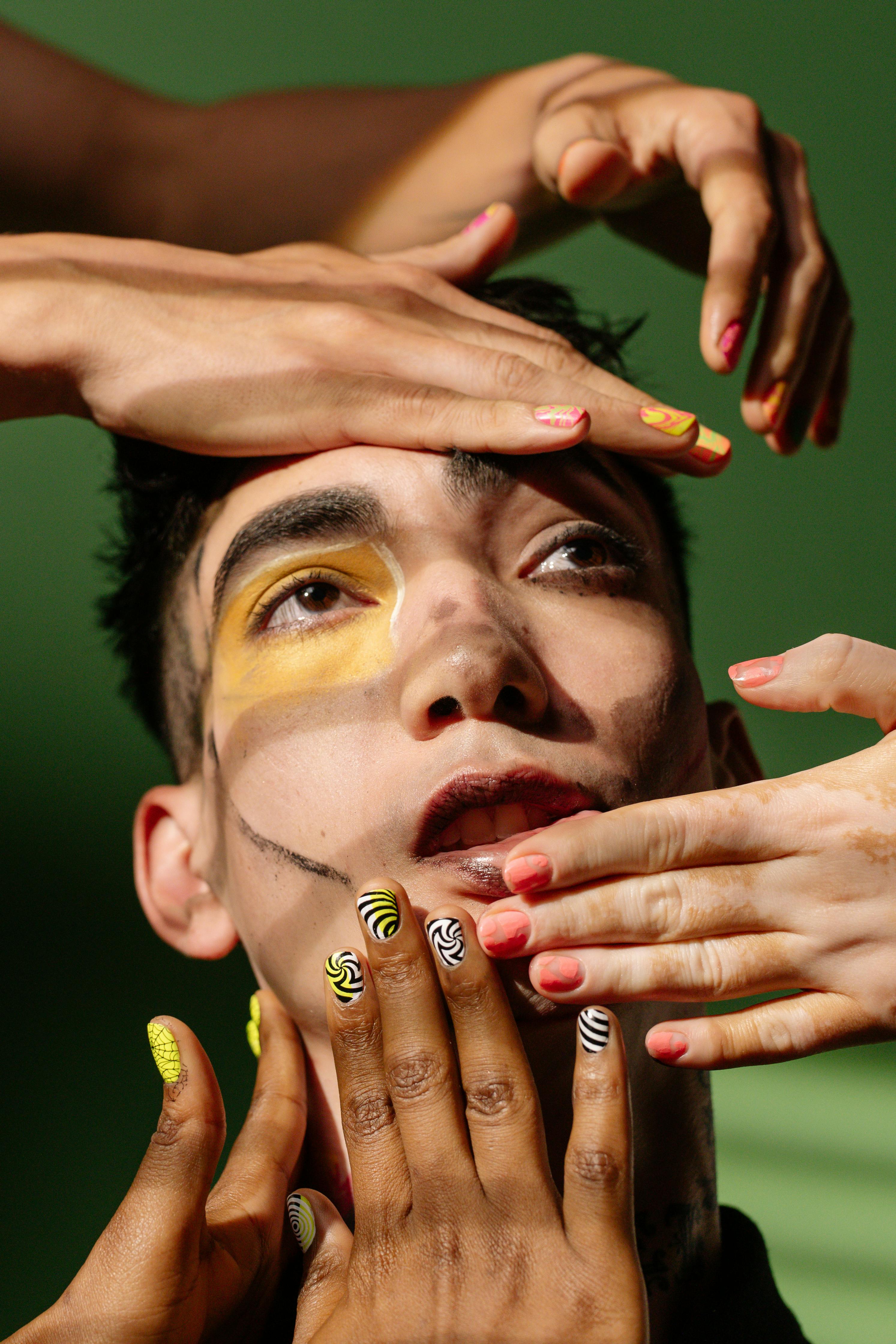 Hands with Nail Art on a Man's Face · Free Stock Photo