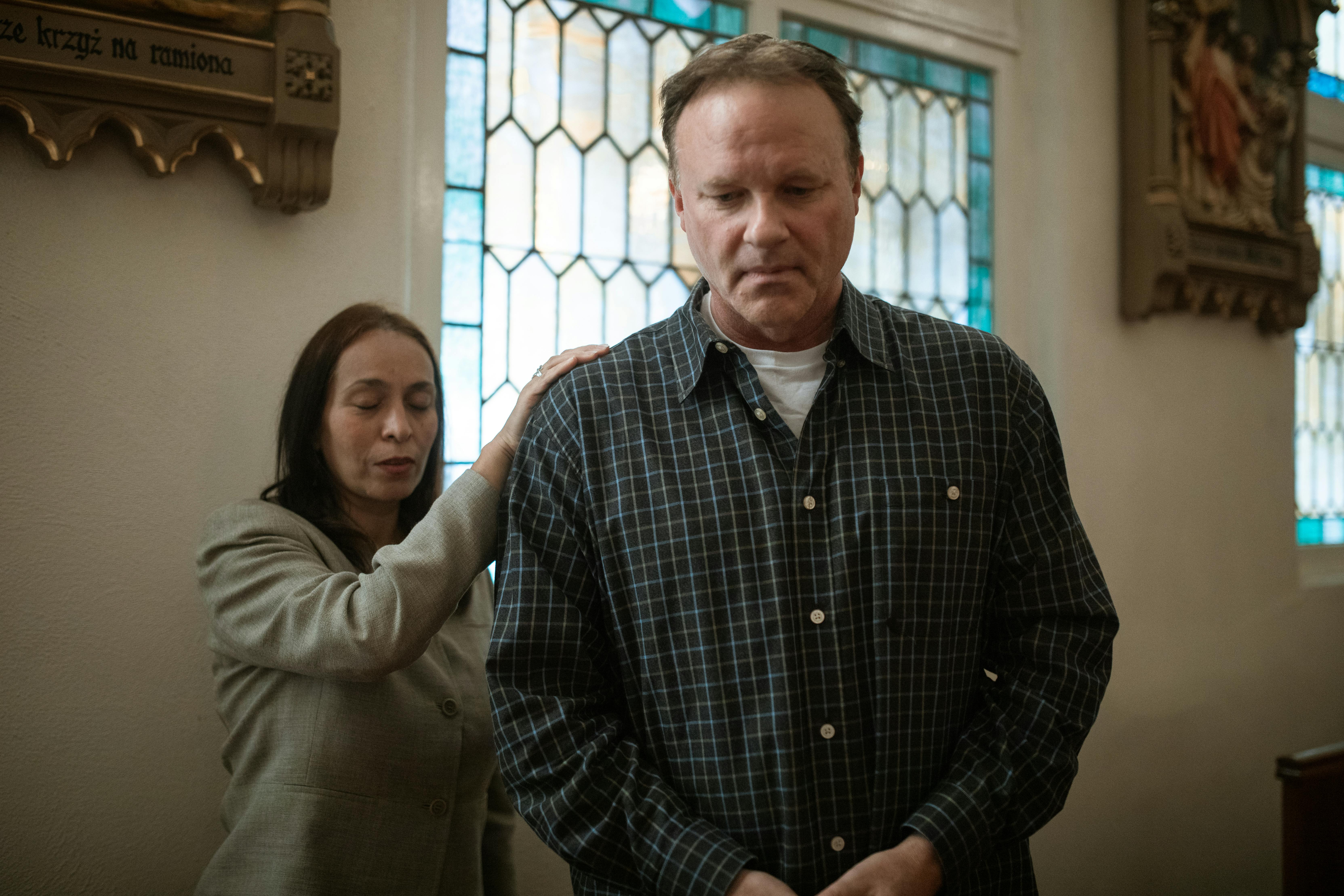 A Man and a Woman Praying inside the Church · Free Stock Photo