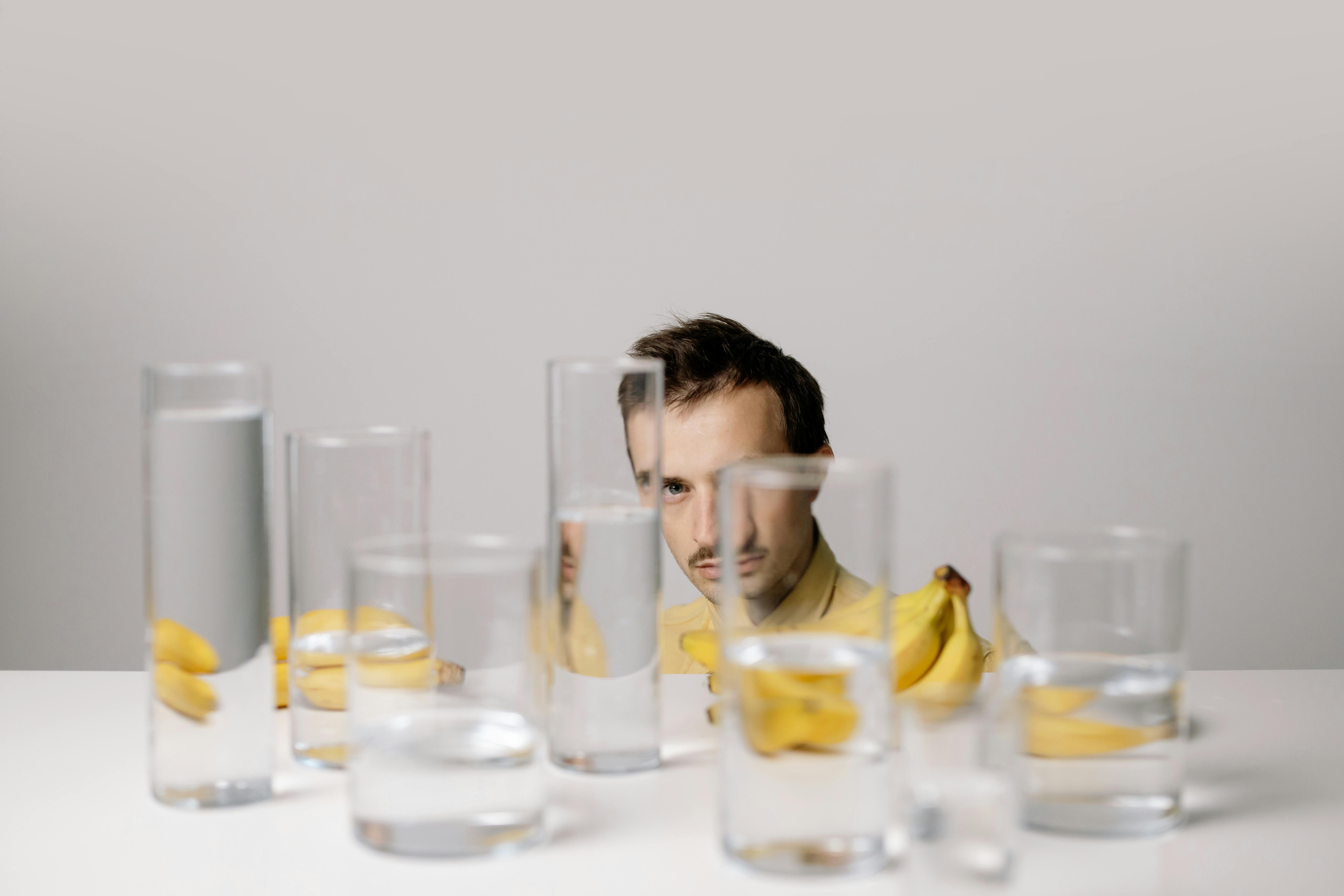 Man behind Glasses of Water · Free Stock Photo