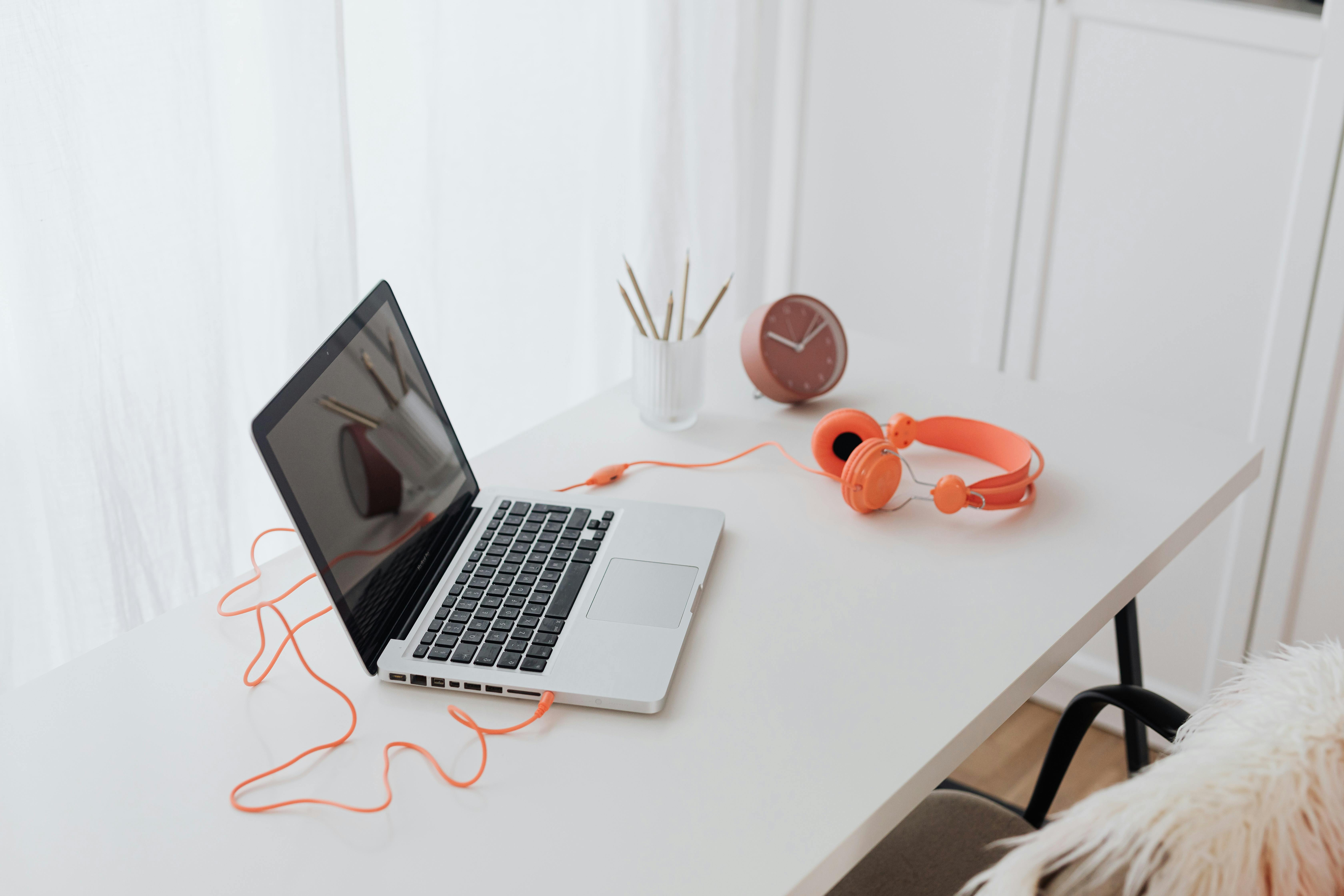 Laptop and Orange Headphones on a Desk · Free Stock Photo
