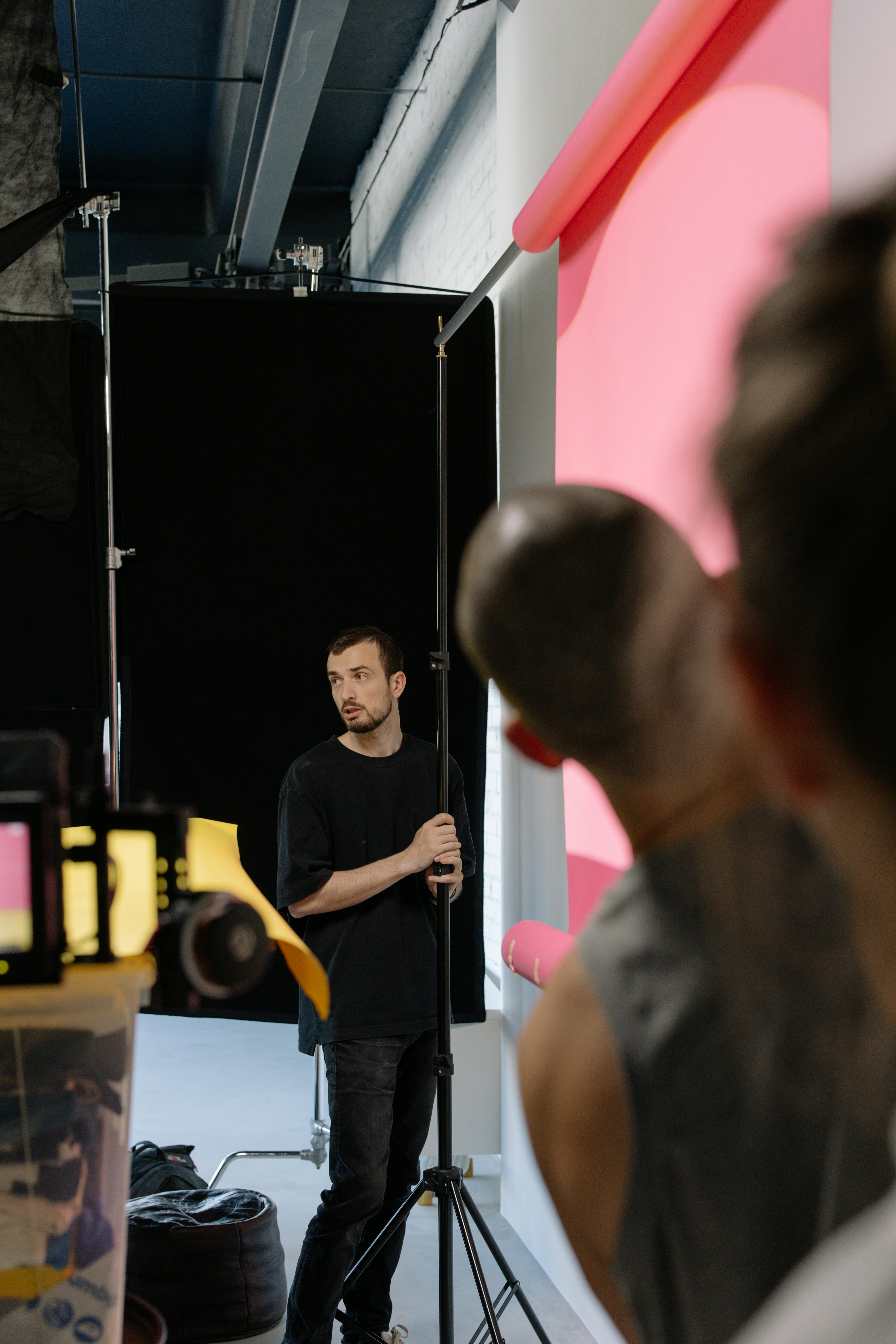 Man Preparing a Studio for a Photo Session · Free Stock Photo