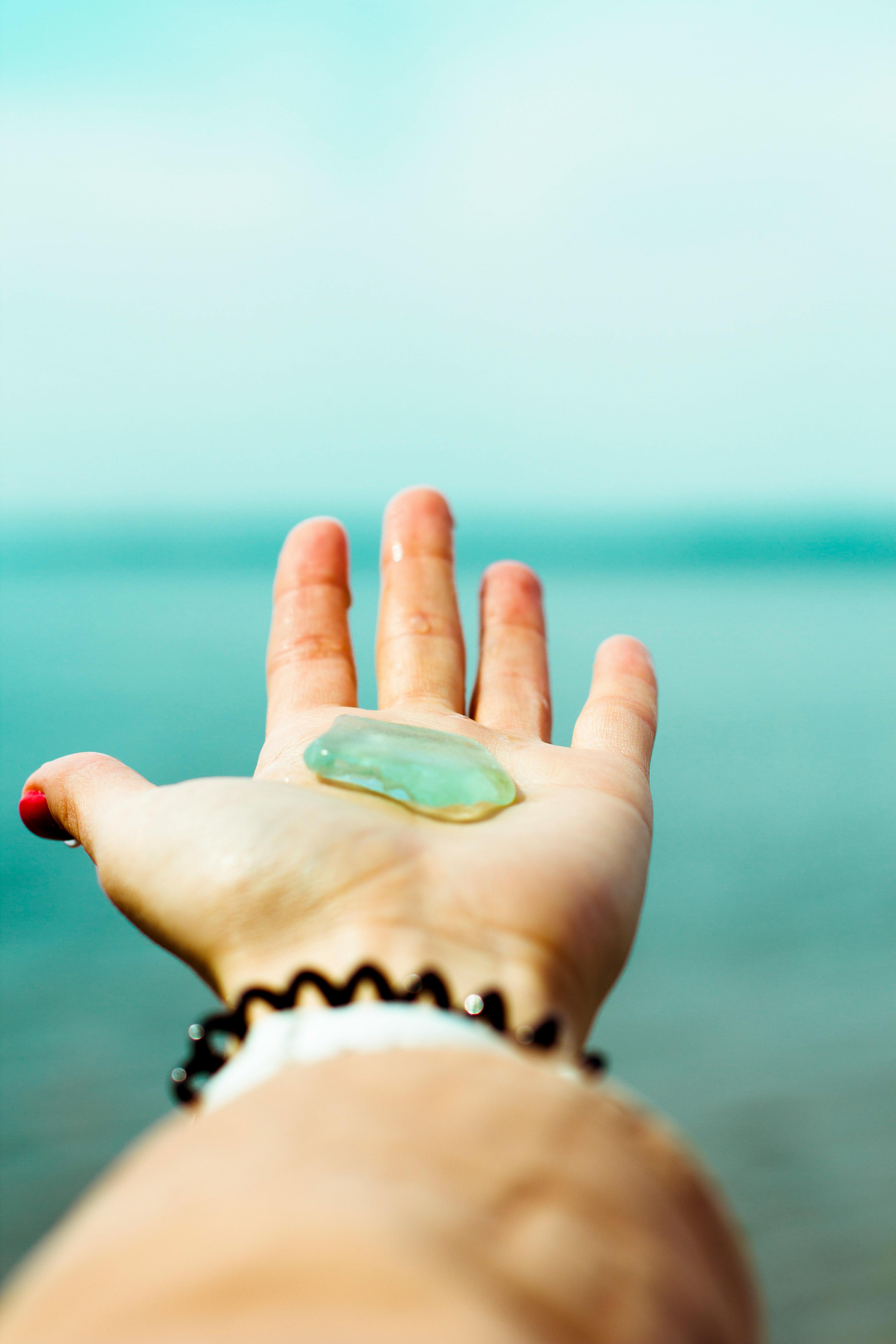 A Person Holding a Sea Glass · Free Stock Photo