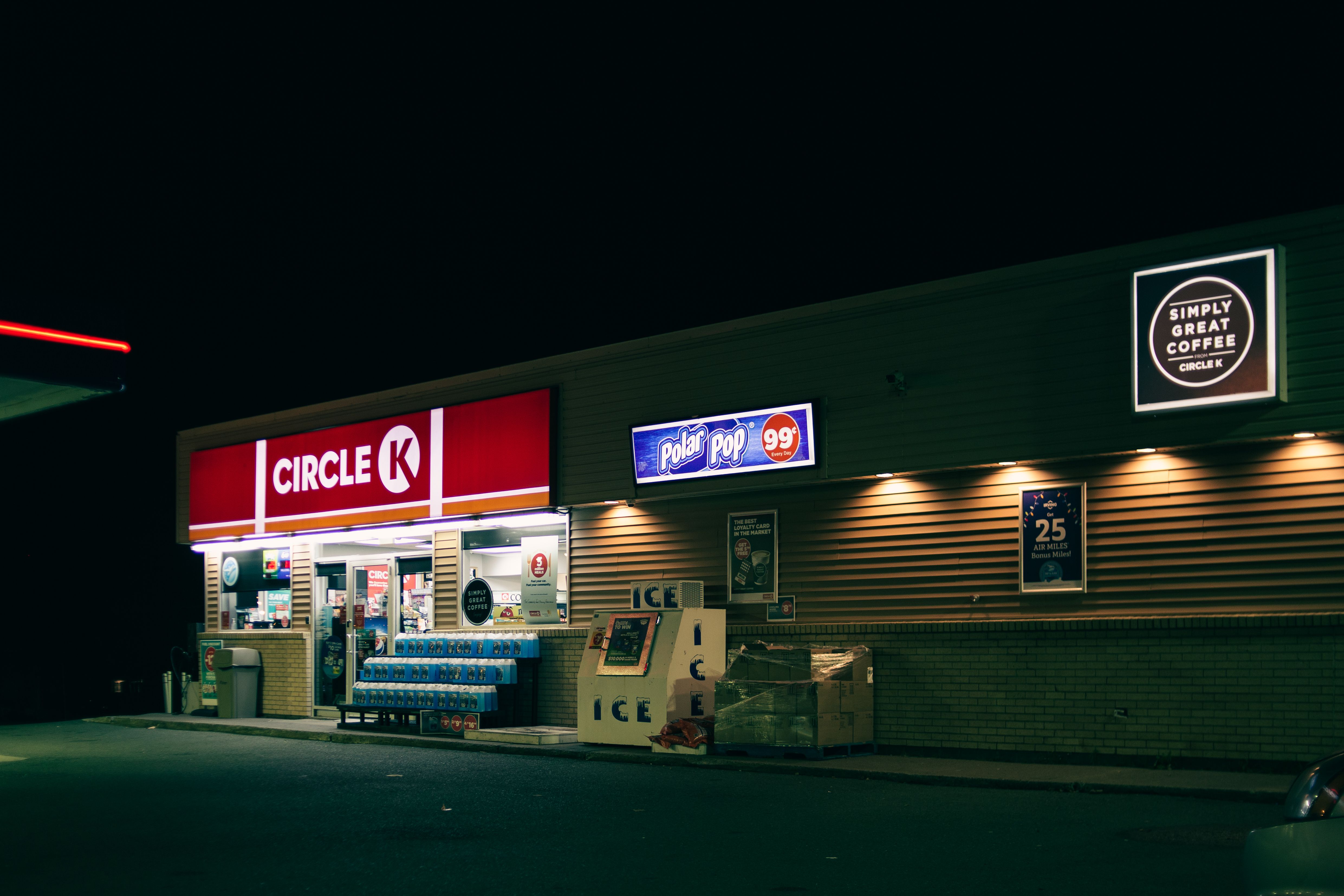 Convenience store building facade with signboards in night city · Free ...