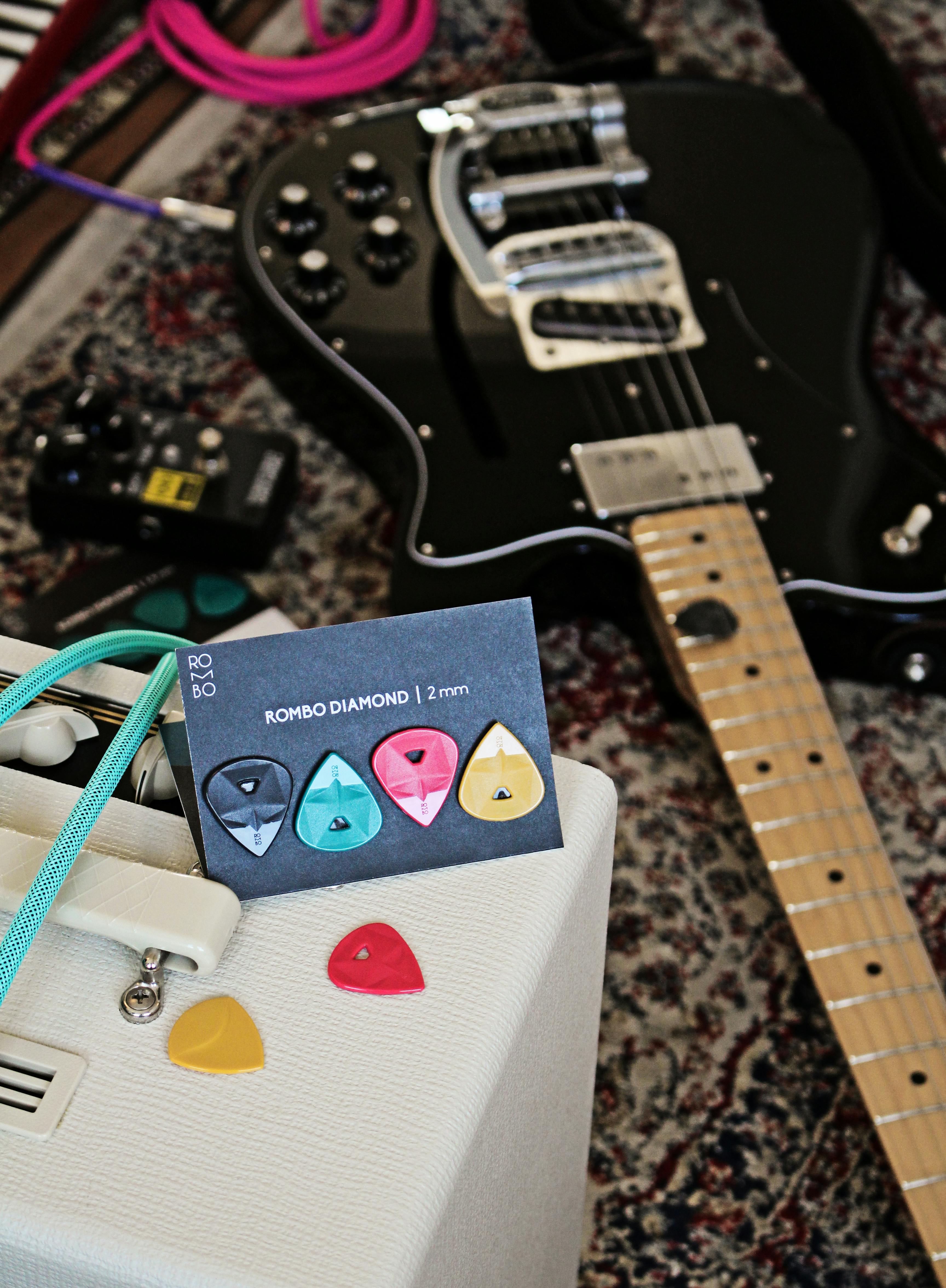 Close-up Photo of Guitar Pick near an Electric Guitar · Free Stock Photo