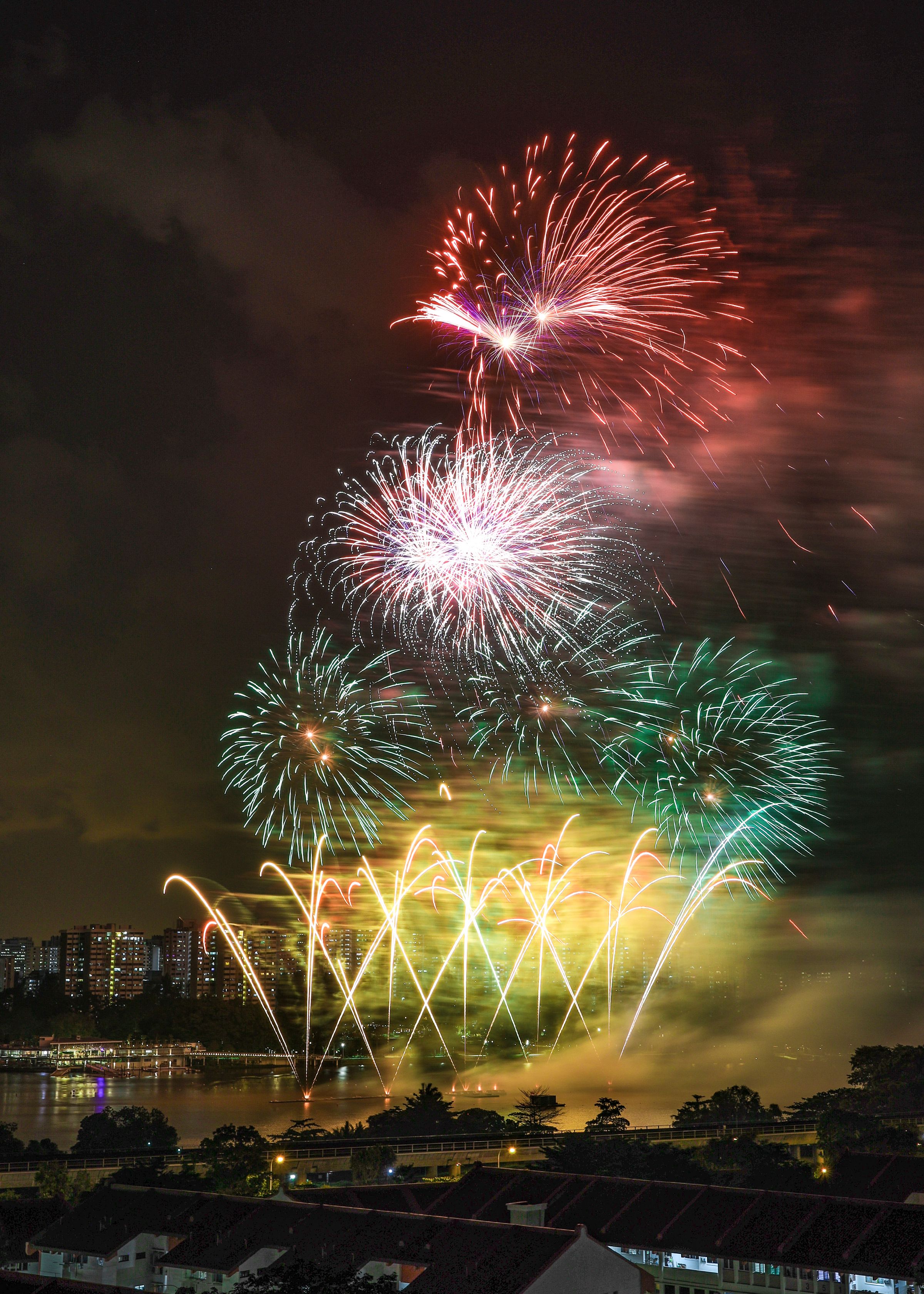 Firework over Illuminated Building · Free Stock Photo