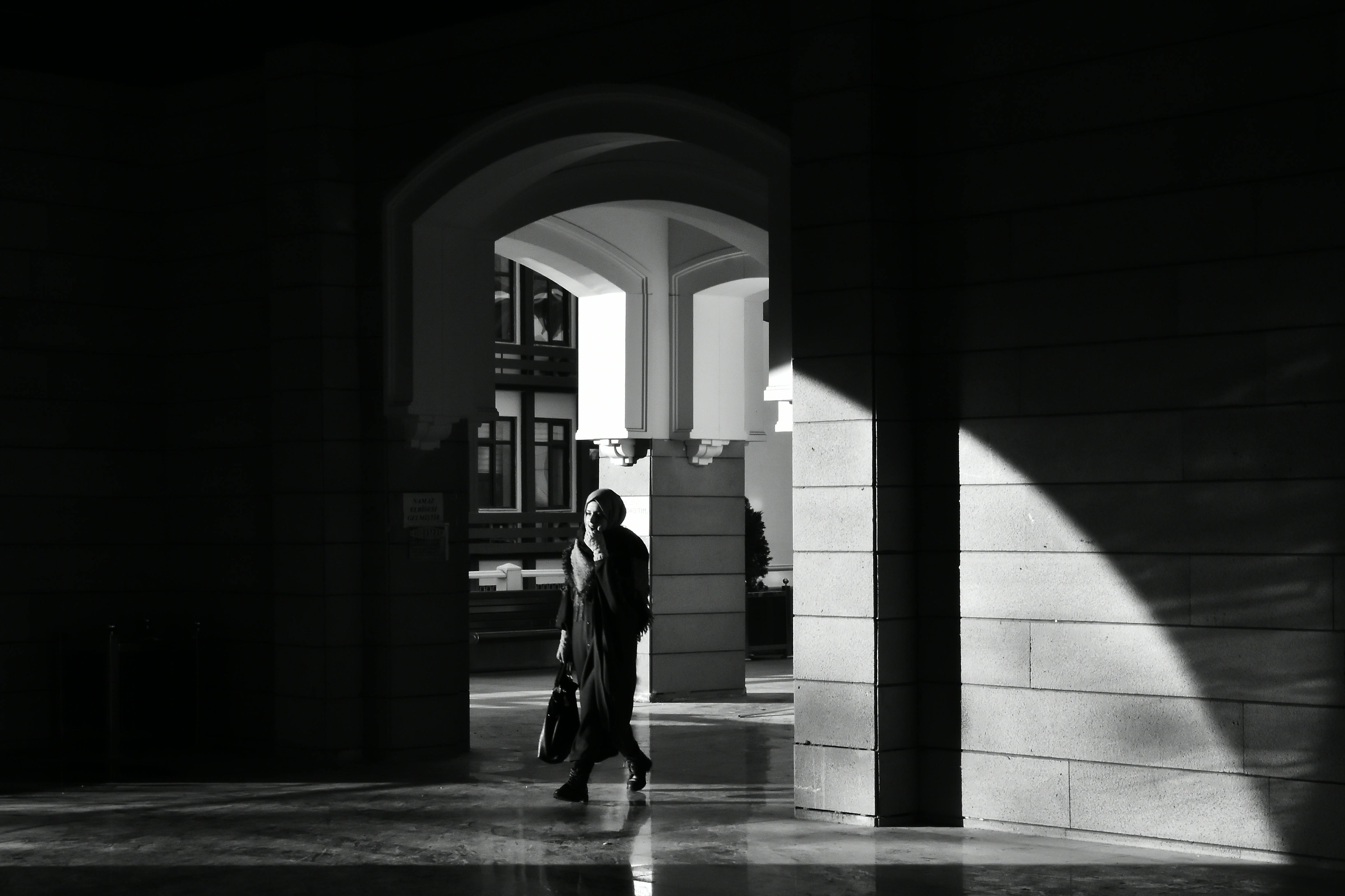 Grayscale Photo Under the Bridge Stand · Free Stock Photo