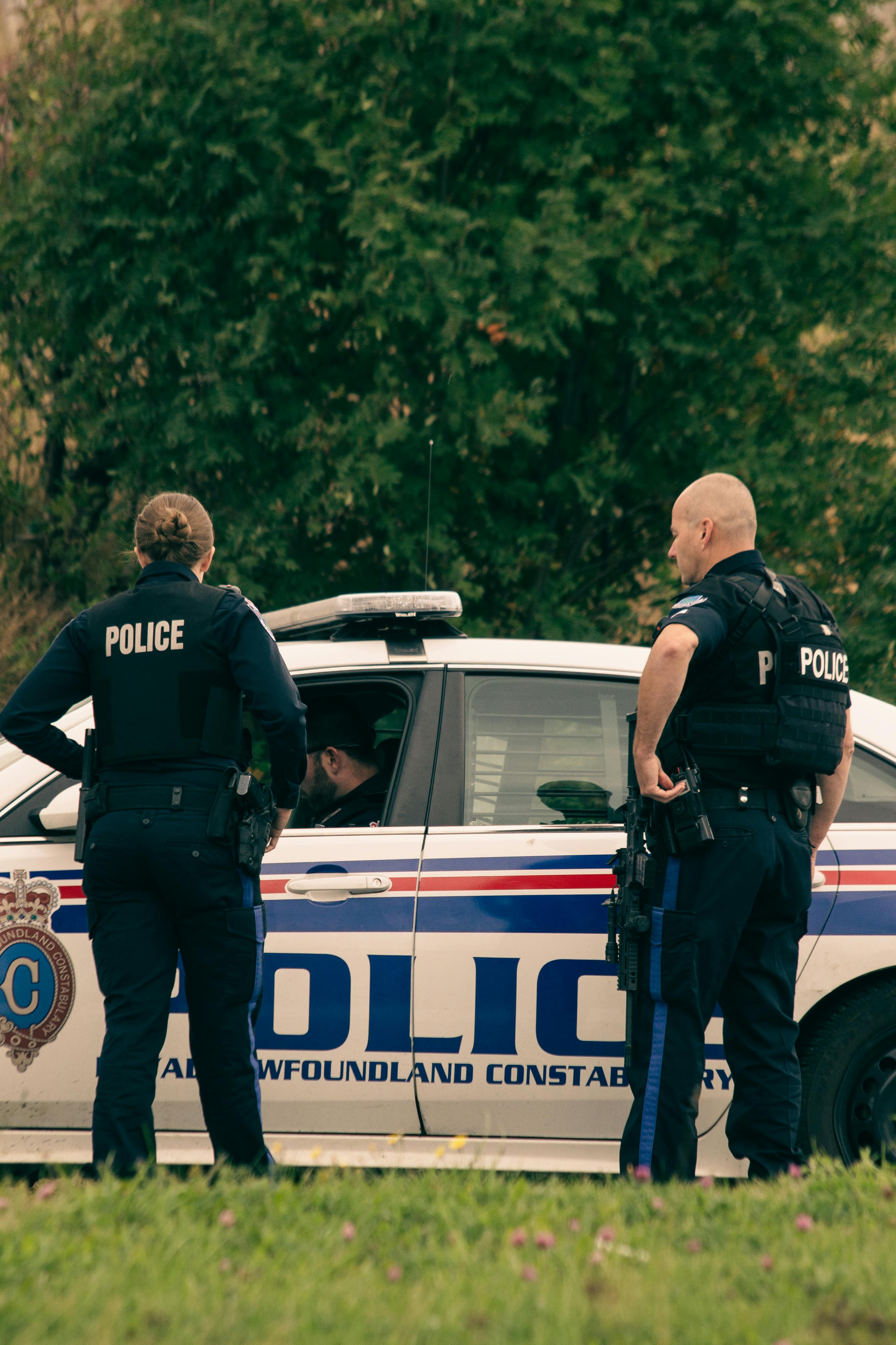 Police Officers Inside a Police Car · Free Stock Photo