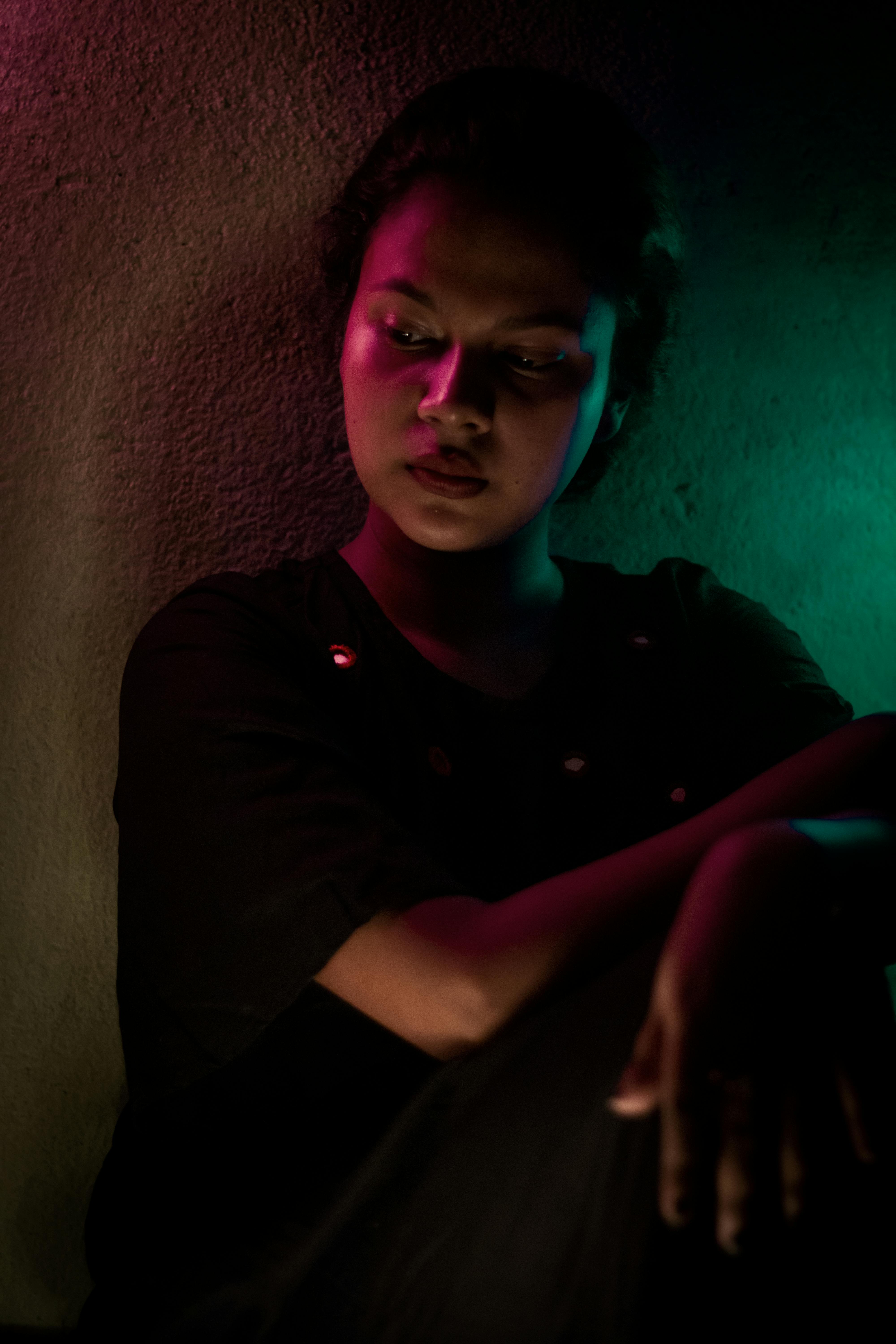 Serious young Indian woman resting in dark room with neon lights · Free ...