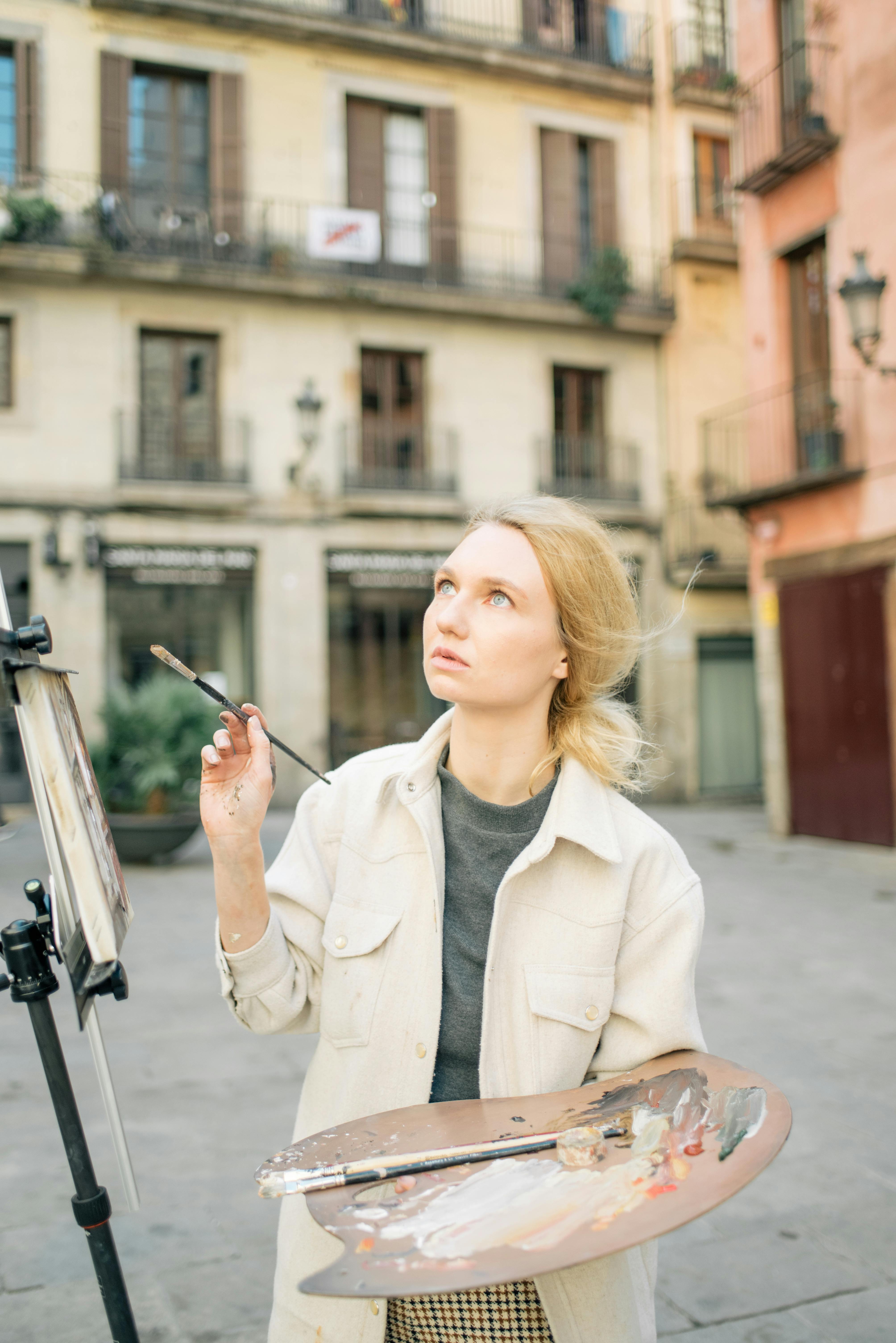 Woman Painting on a Wall · Free Stock Photo