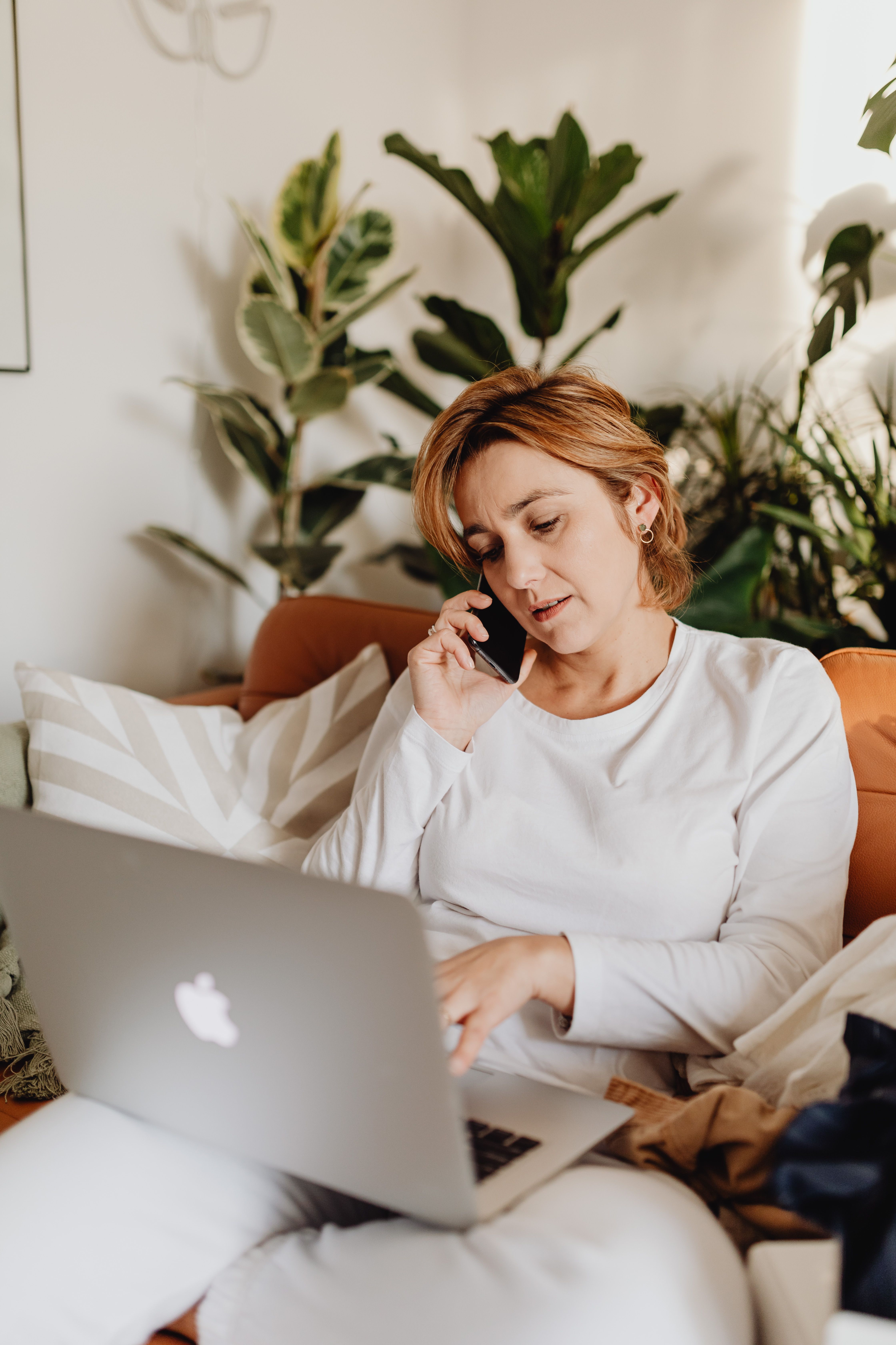 Person Using Dell Laptop While Sitting On Sofa Inside Room · Free Stock ...