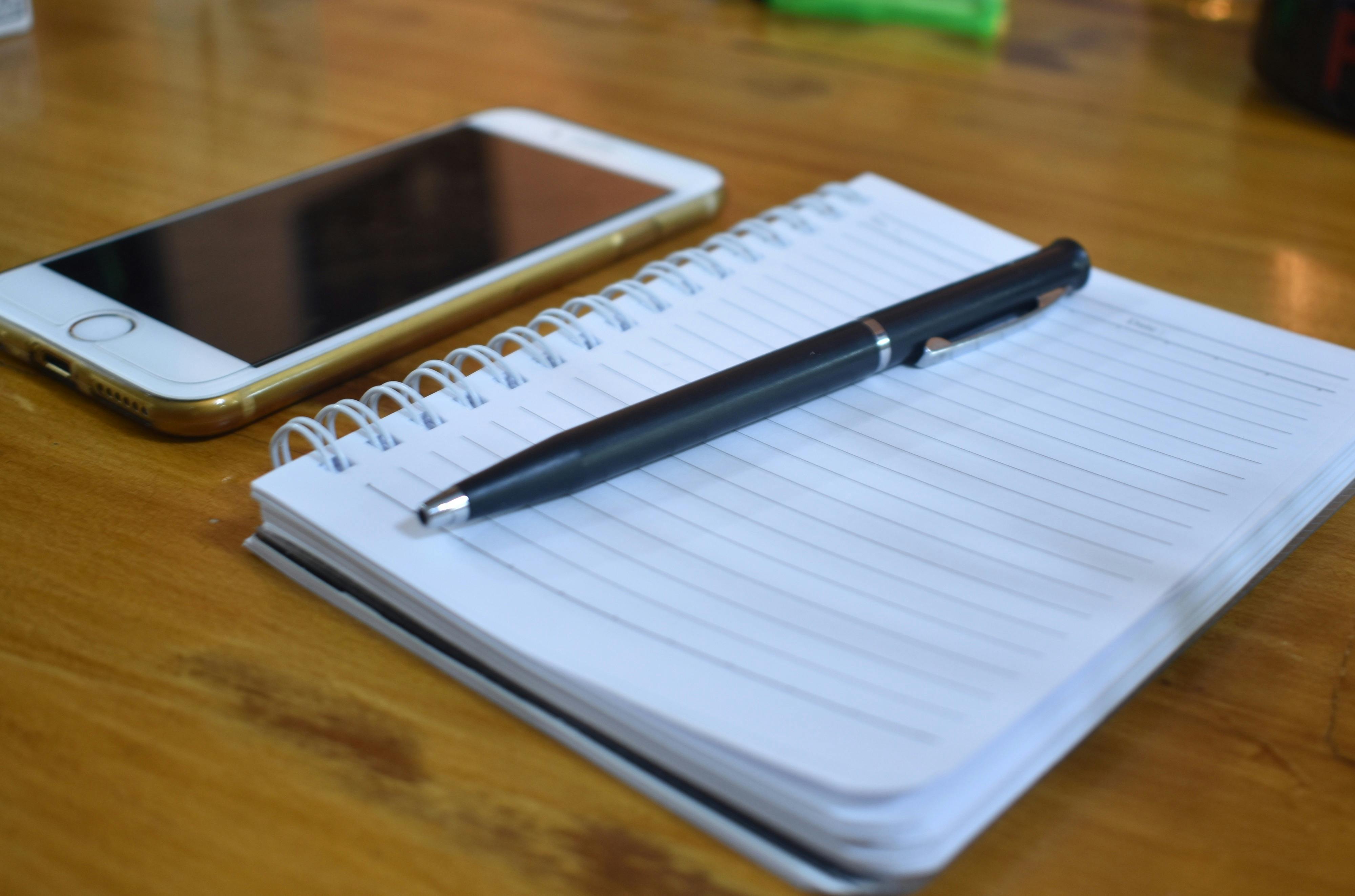 Free stock photo of notebook, notebook and smartphone, pen