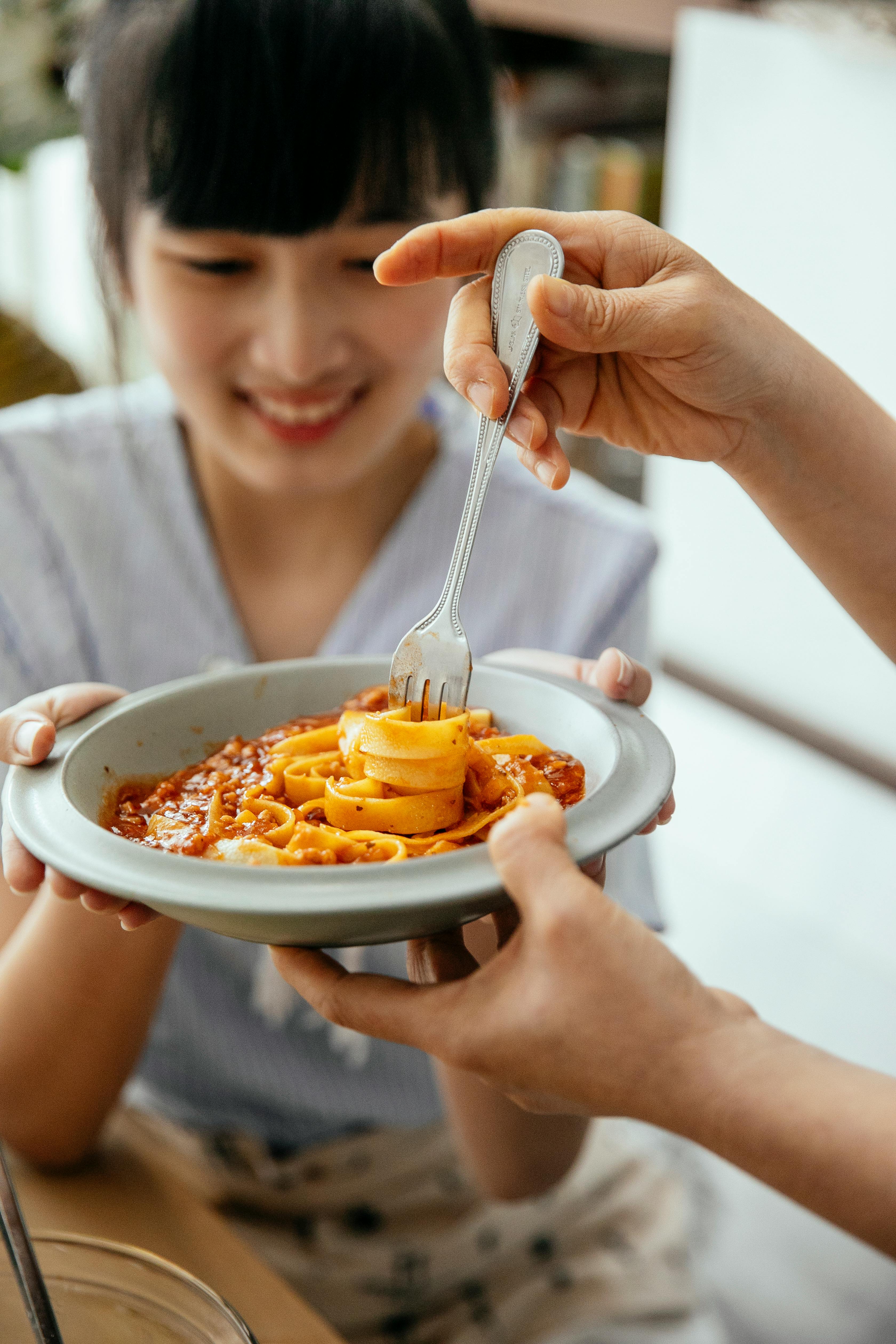 Smiling Woman Eating Pasta in Restaurant · Free Stock Photo