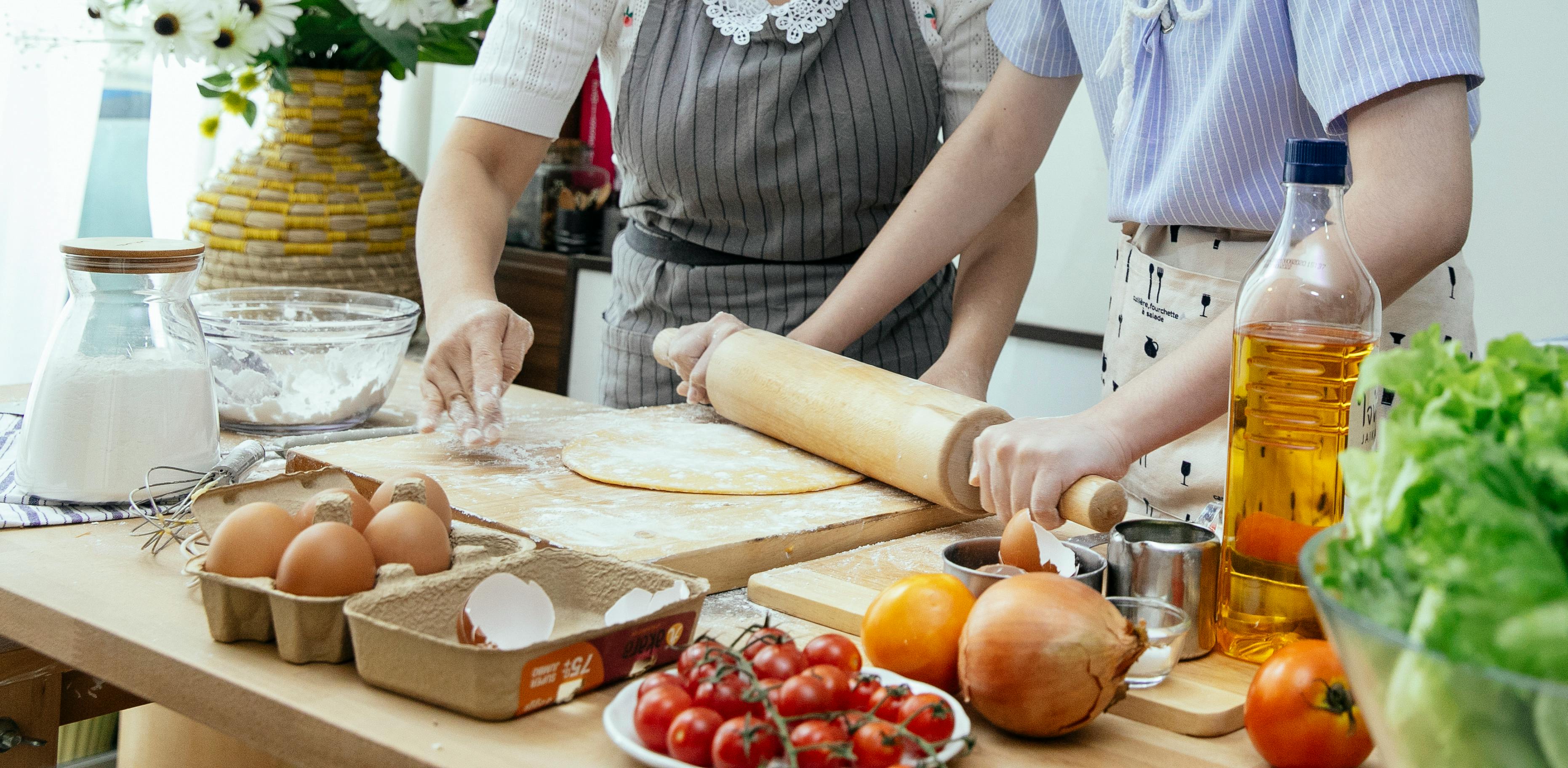 Crop women flattening dough in kitchen · Free Stock Photo