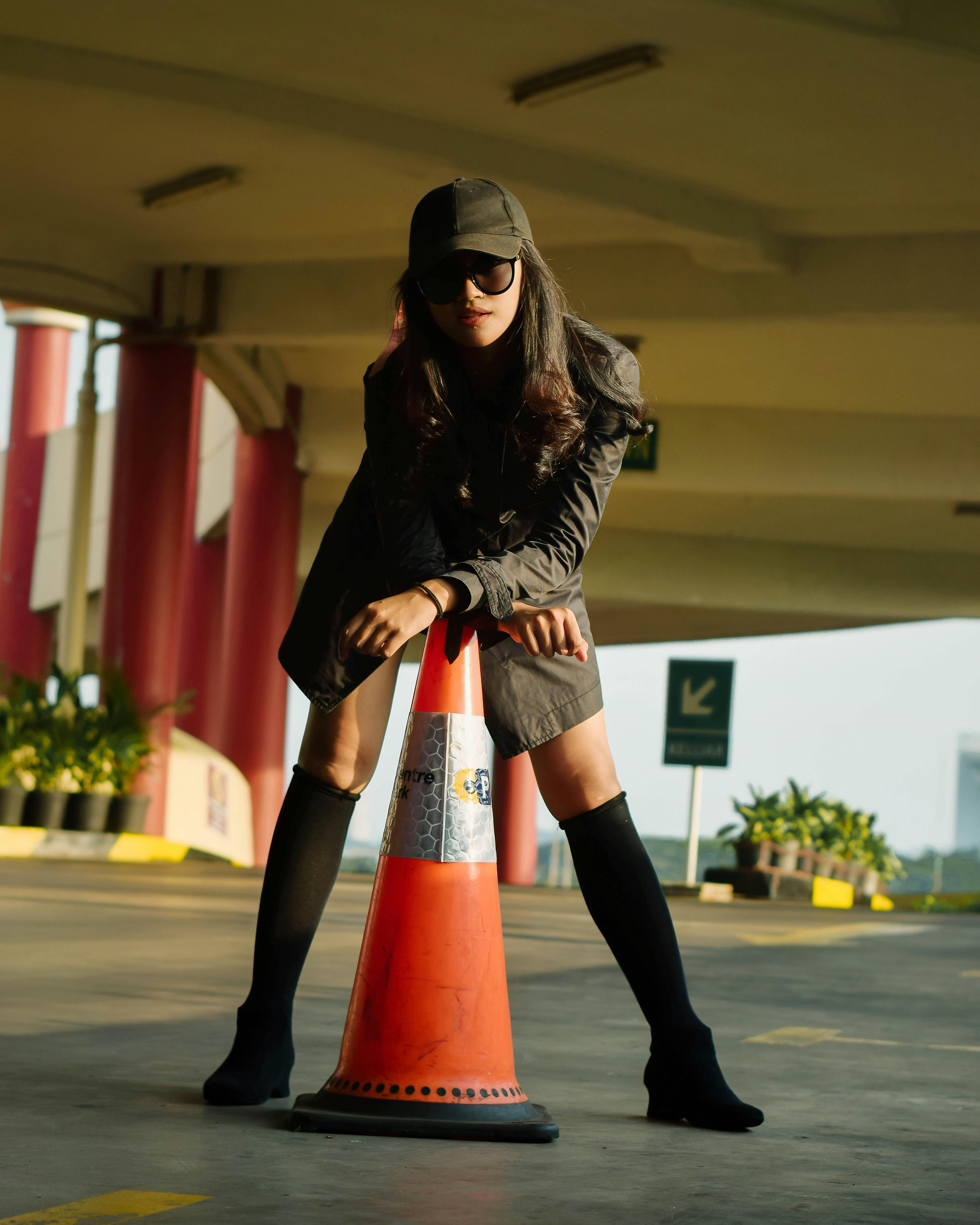 Woman Posing on a Traffic Cone · Free Stock Photo