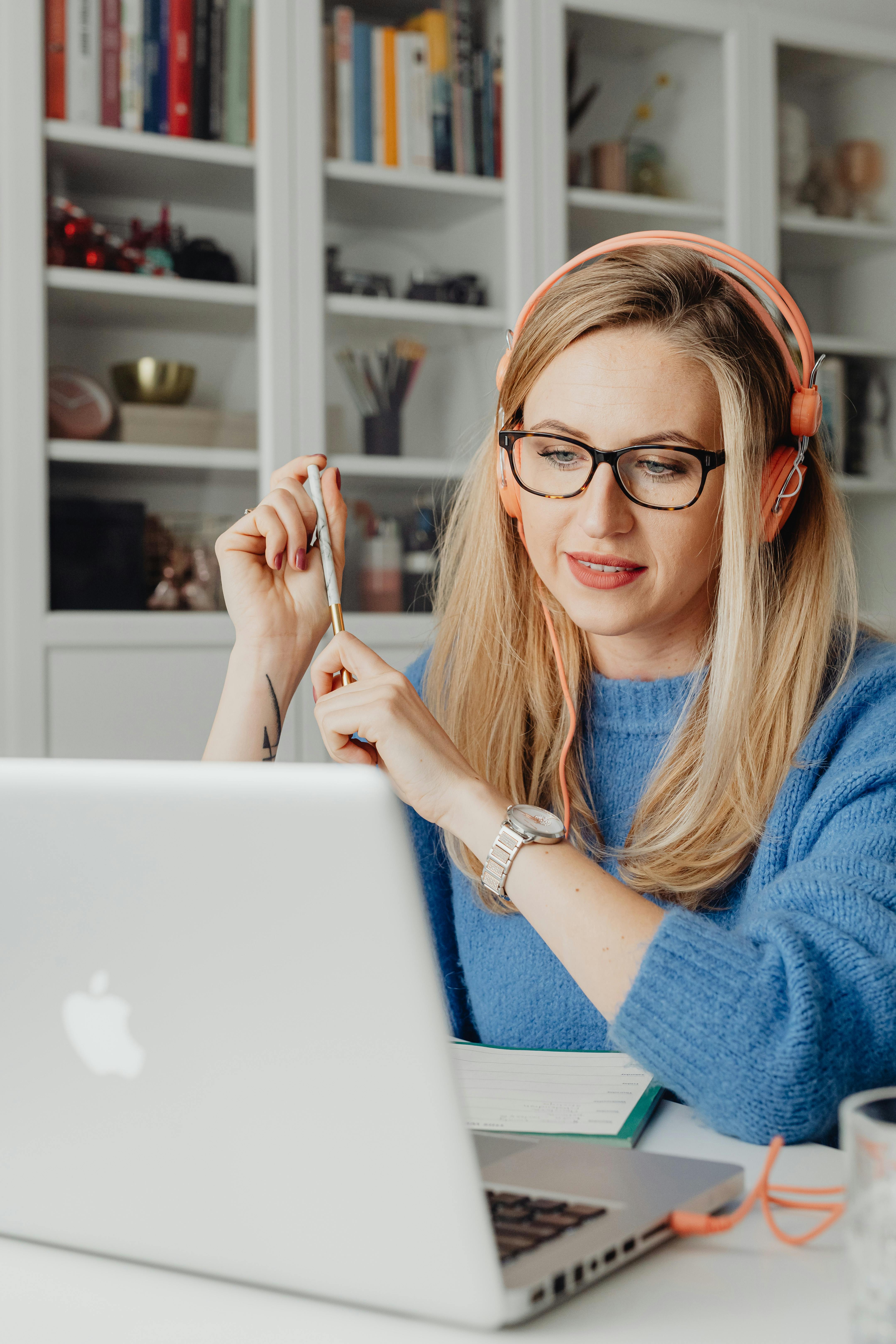 Woman Sitting by the Table Using A Computer Laptop · Free Stock Photo