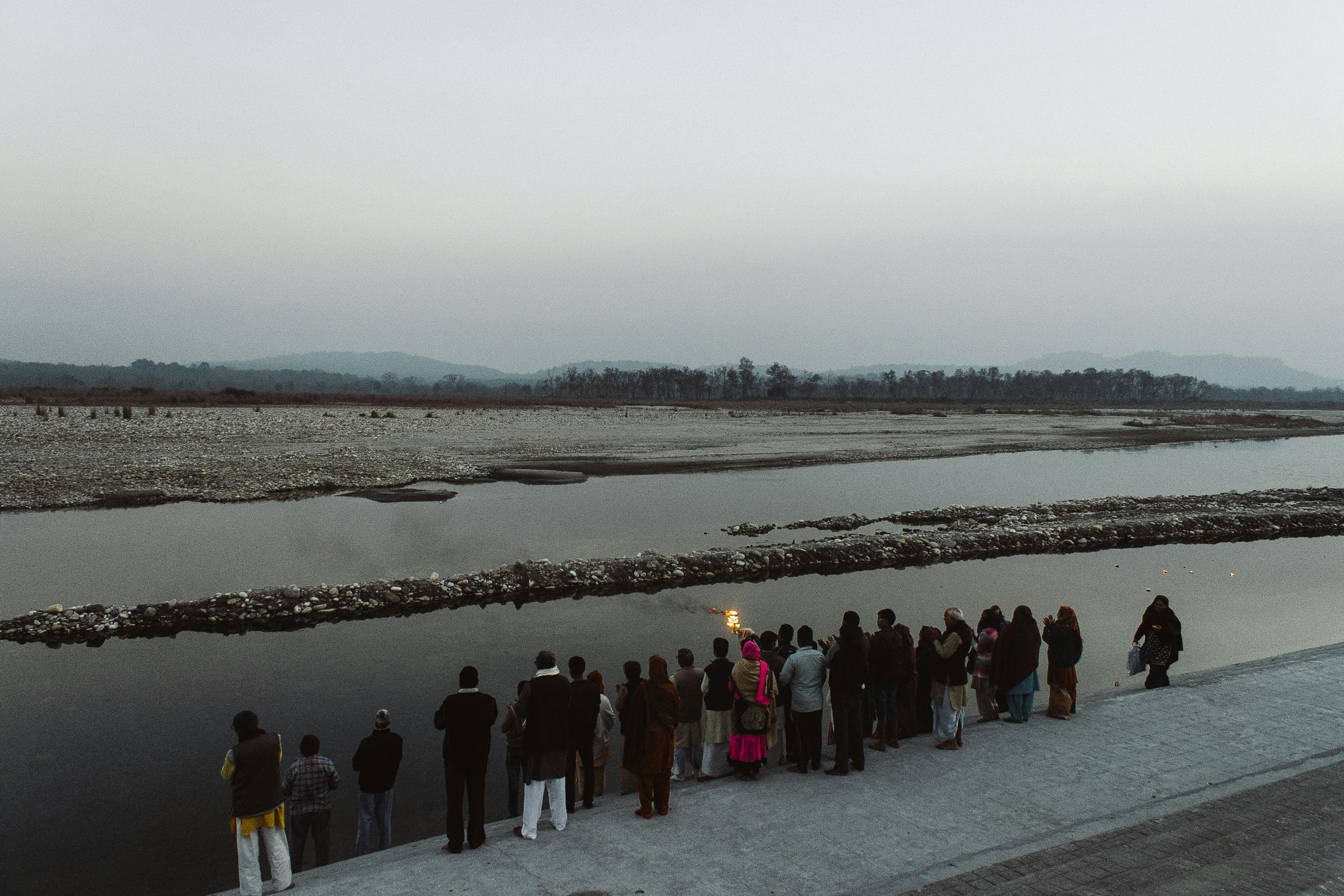 People standing on embankment near river · Free Stock Photo