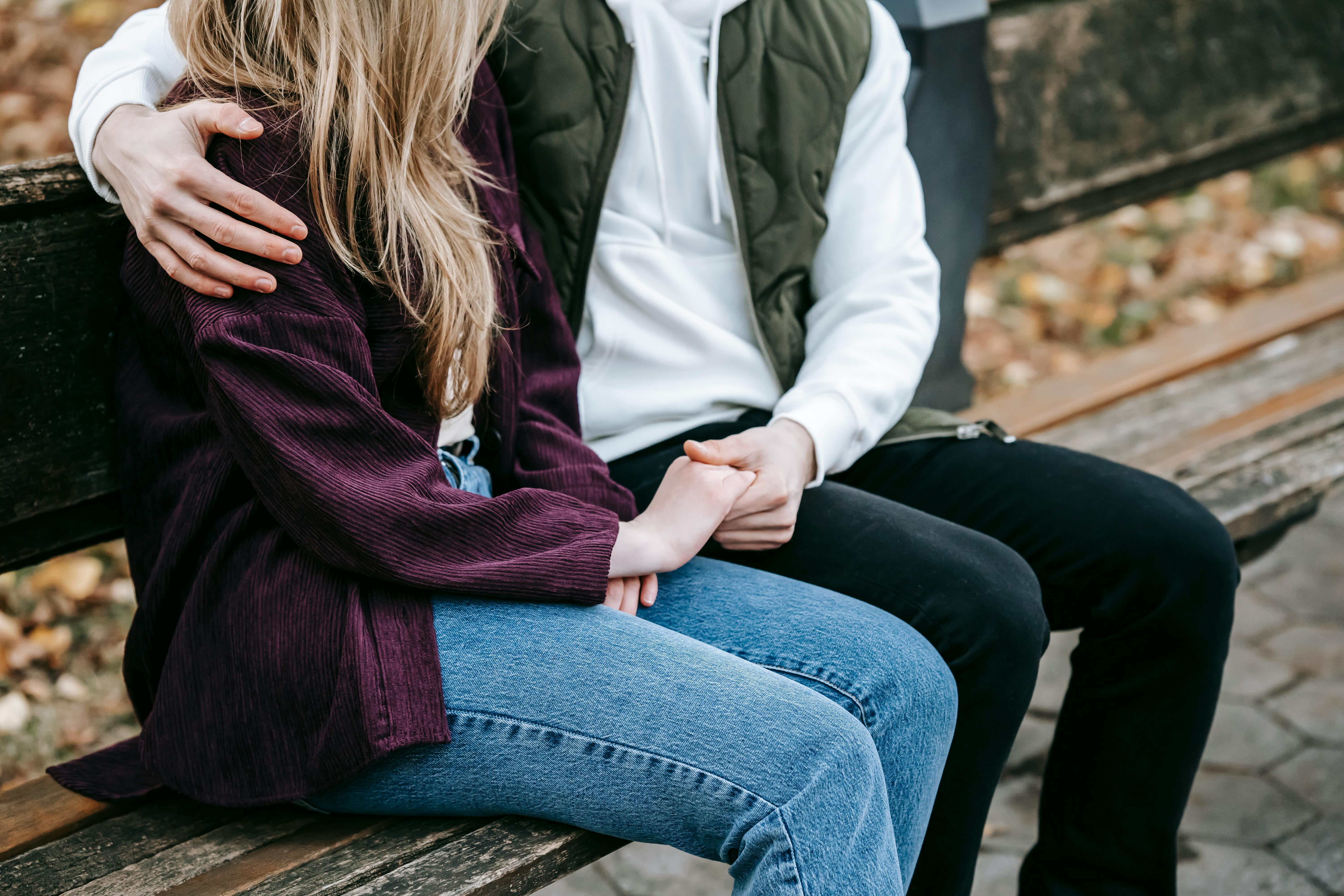 Romantic young couple cuddling during date in countryside at night ...