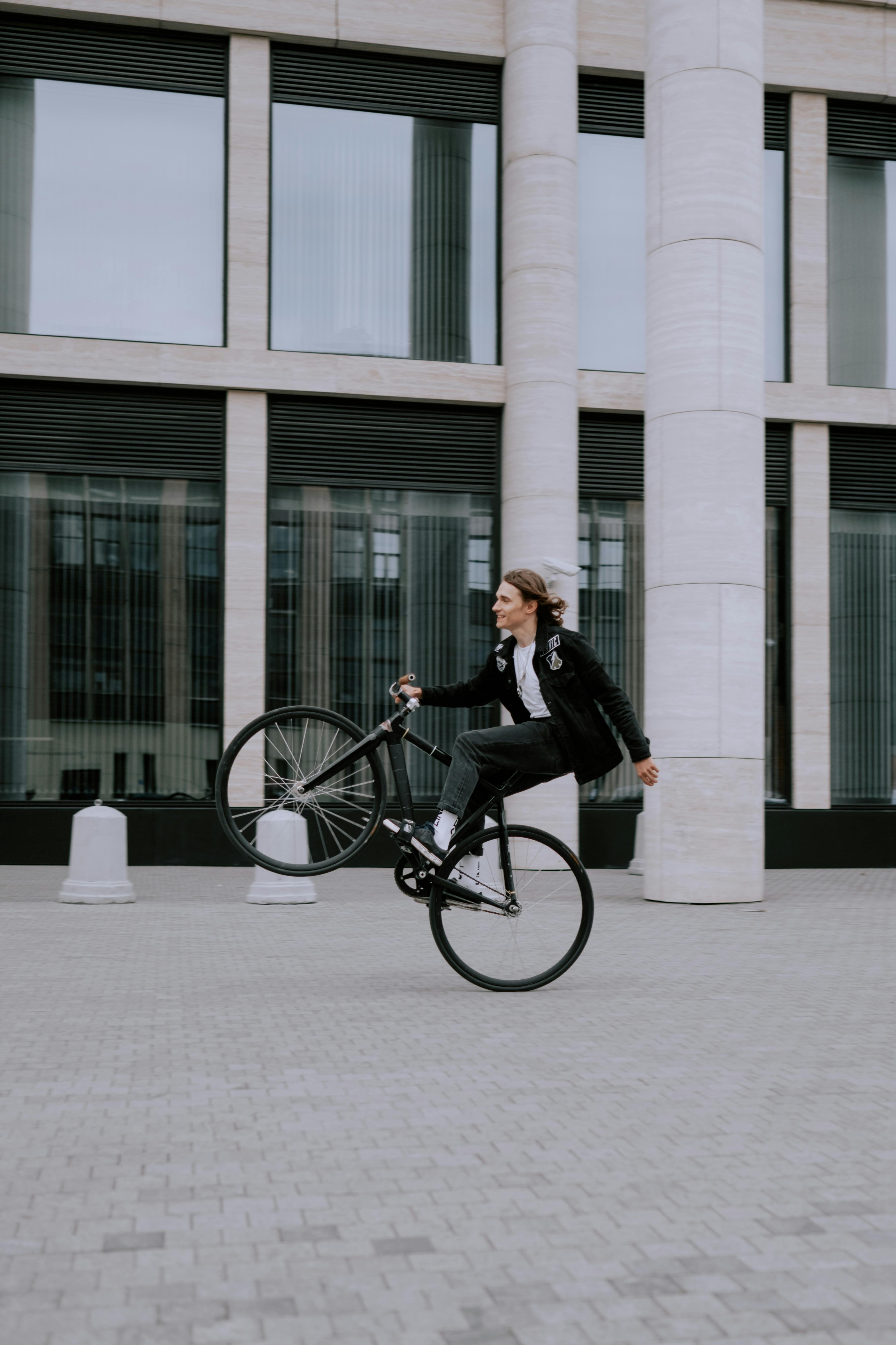 A Man Riding Fixie doing Wheelie · Free Stock Photo