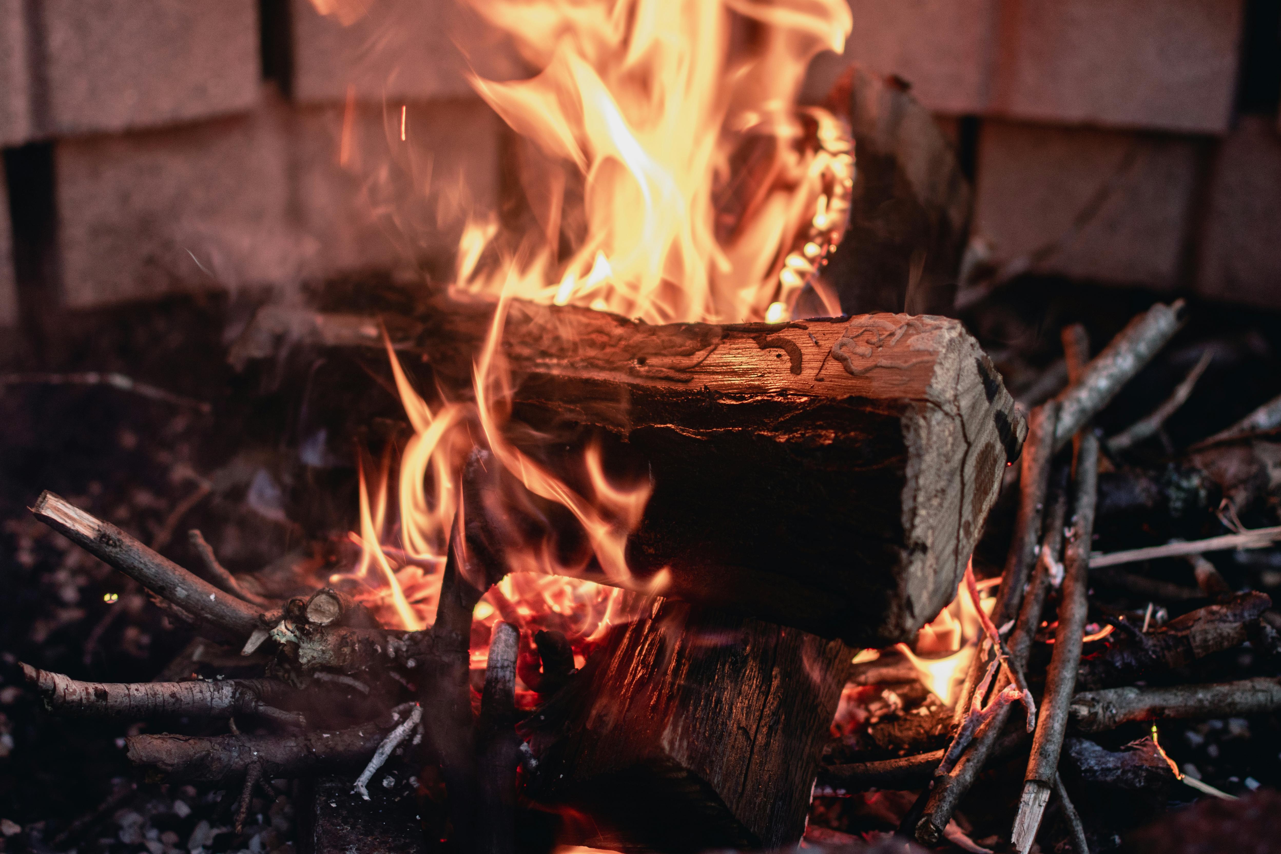 Burning Wood Above Rocks · Free Stock Photo