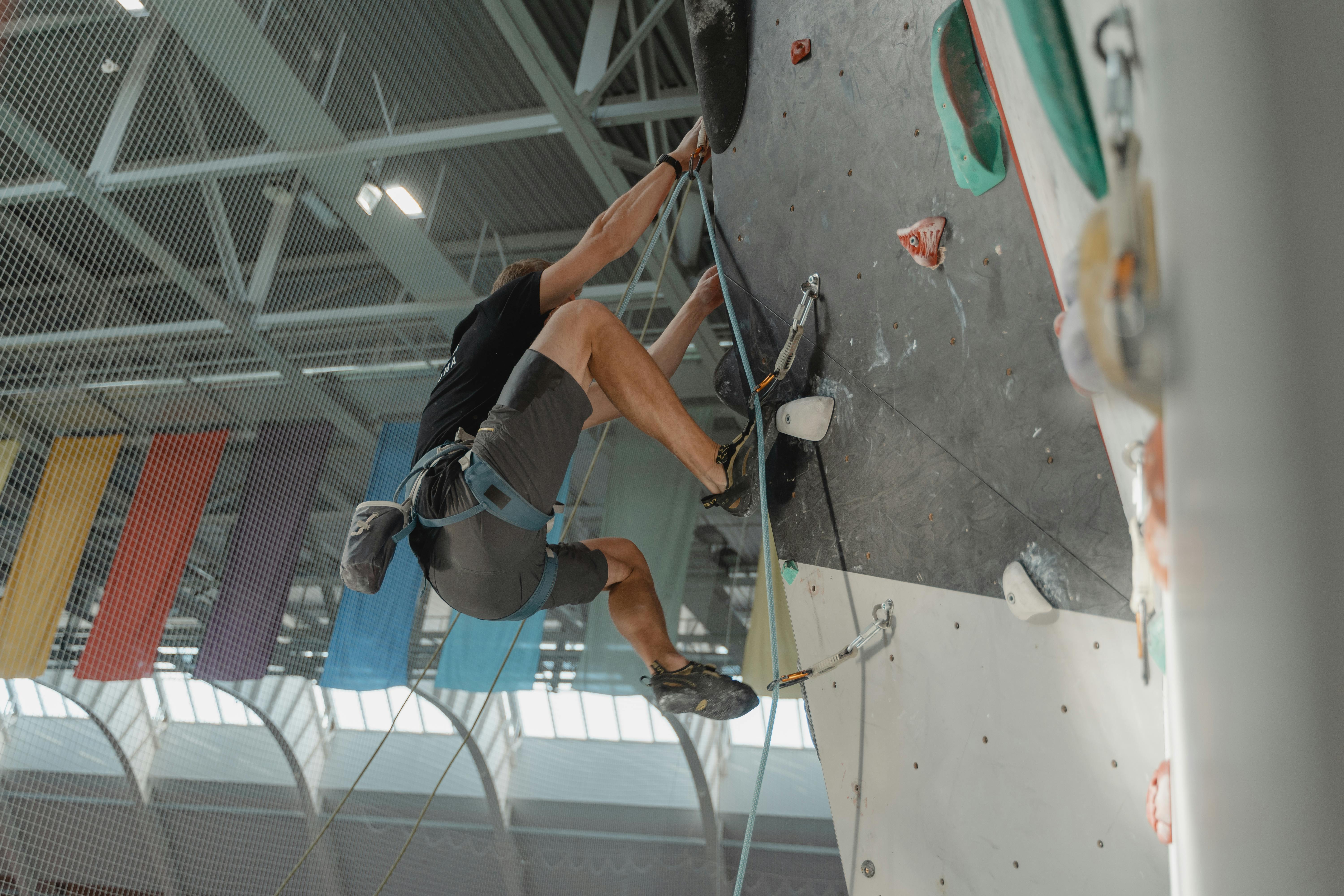 Climber Hanging on a Wall · Free Stock Photo