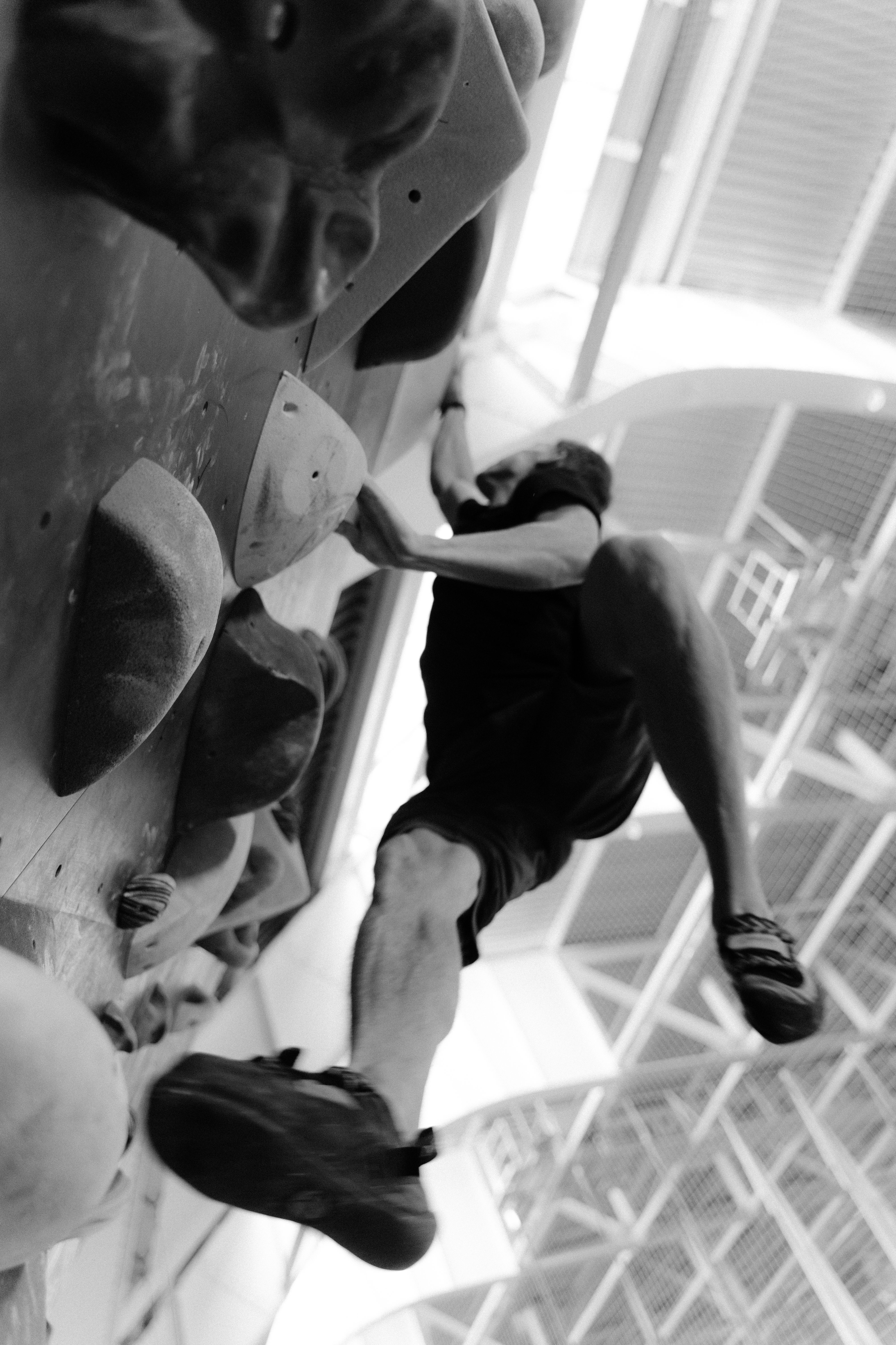Black and White Photo of a Man Climbing a Mountain · Free Stock Photo
