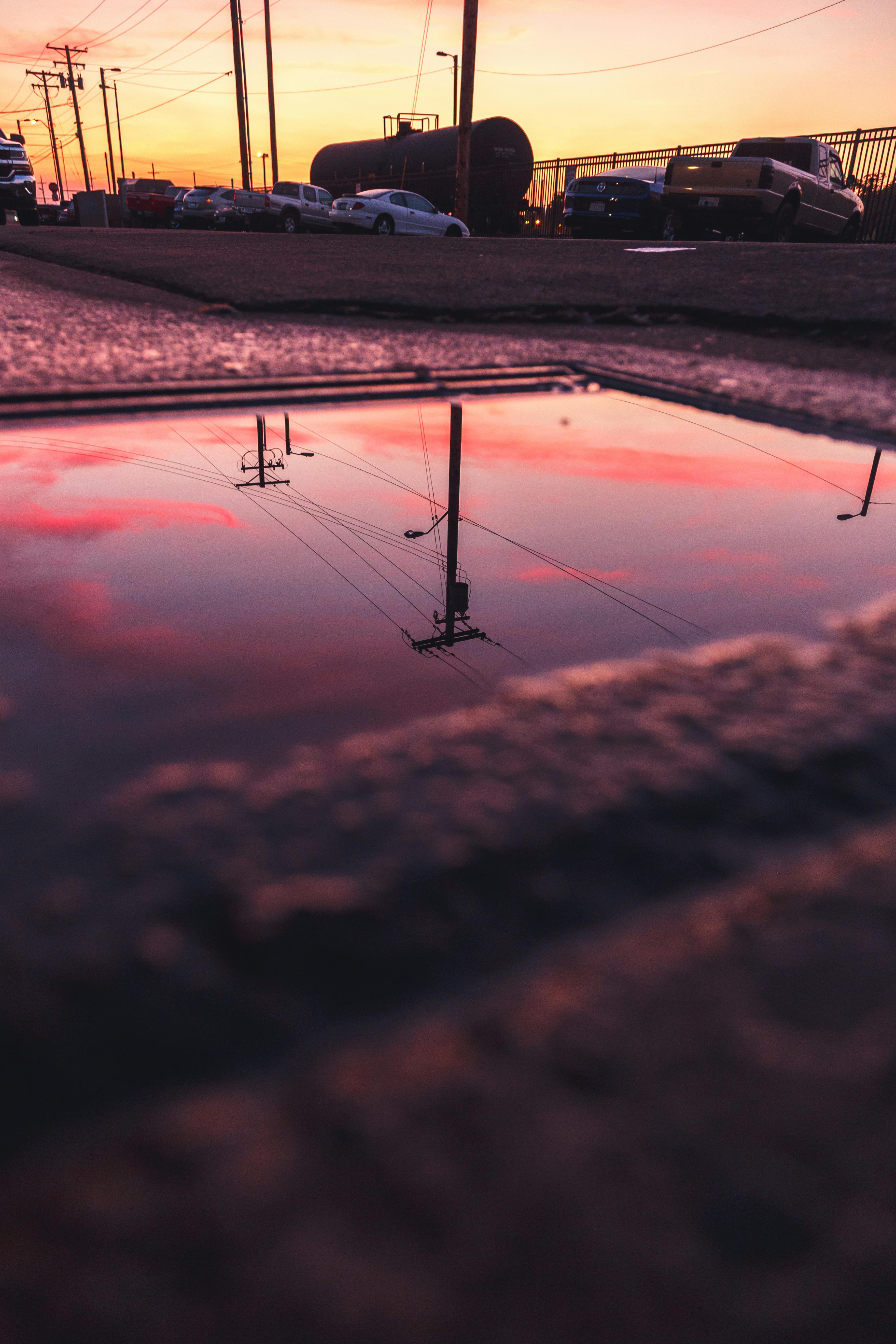 Reflection of Electric Poles on a Puddle · Free Stock Photo