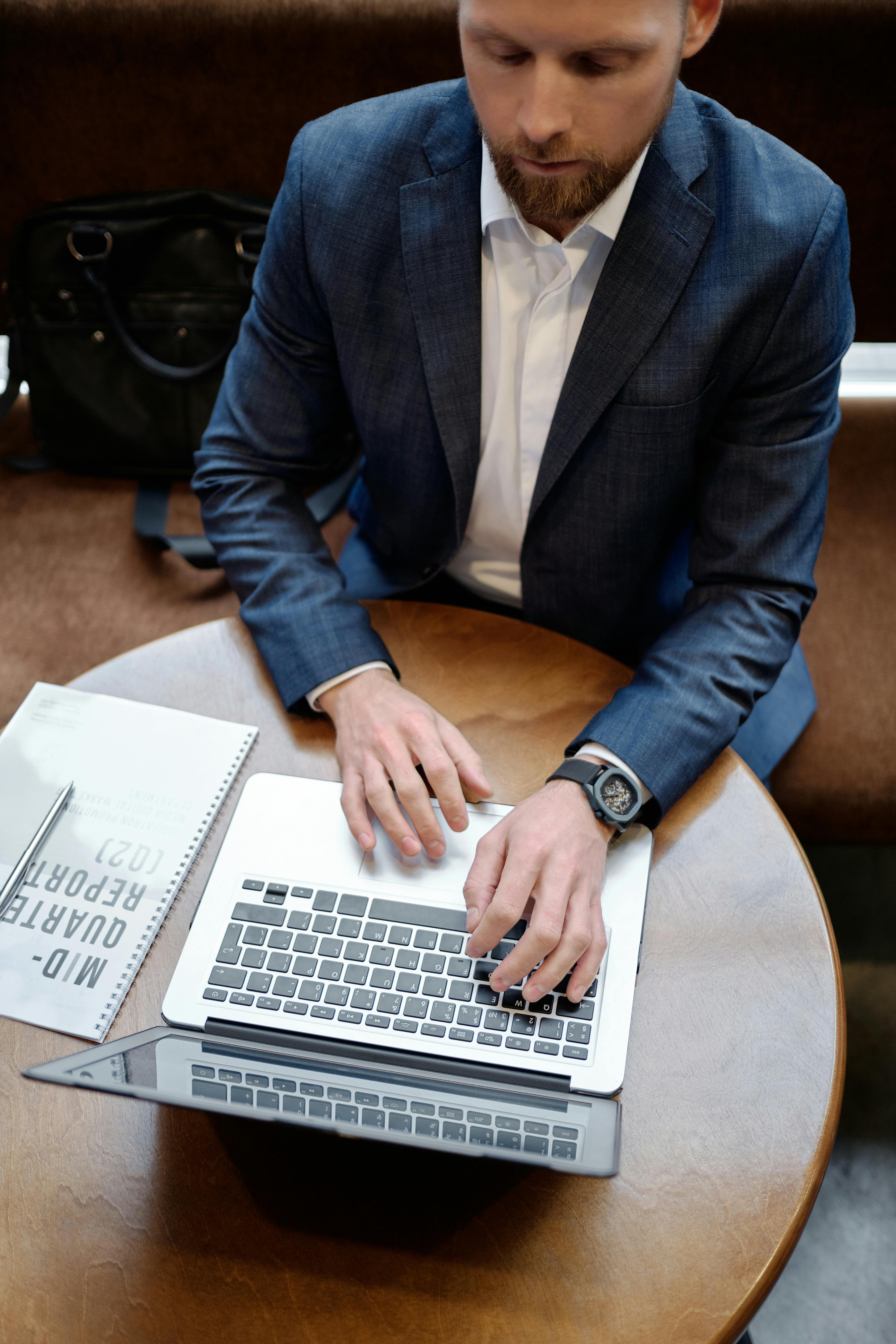 Man in Blue Suit Jacket Using Macbook Pro · Free Stock Photo