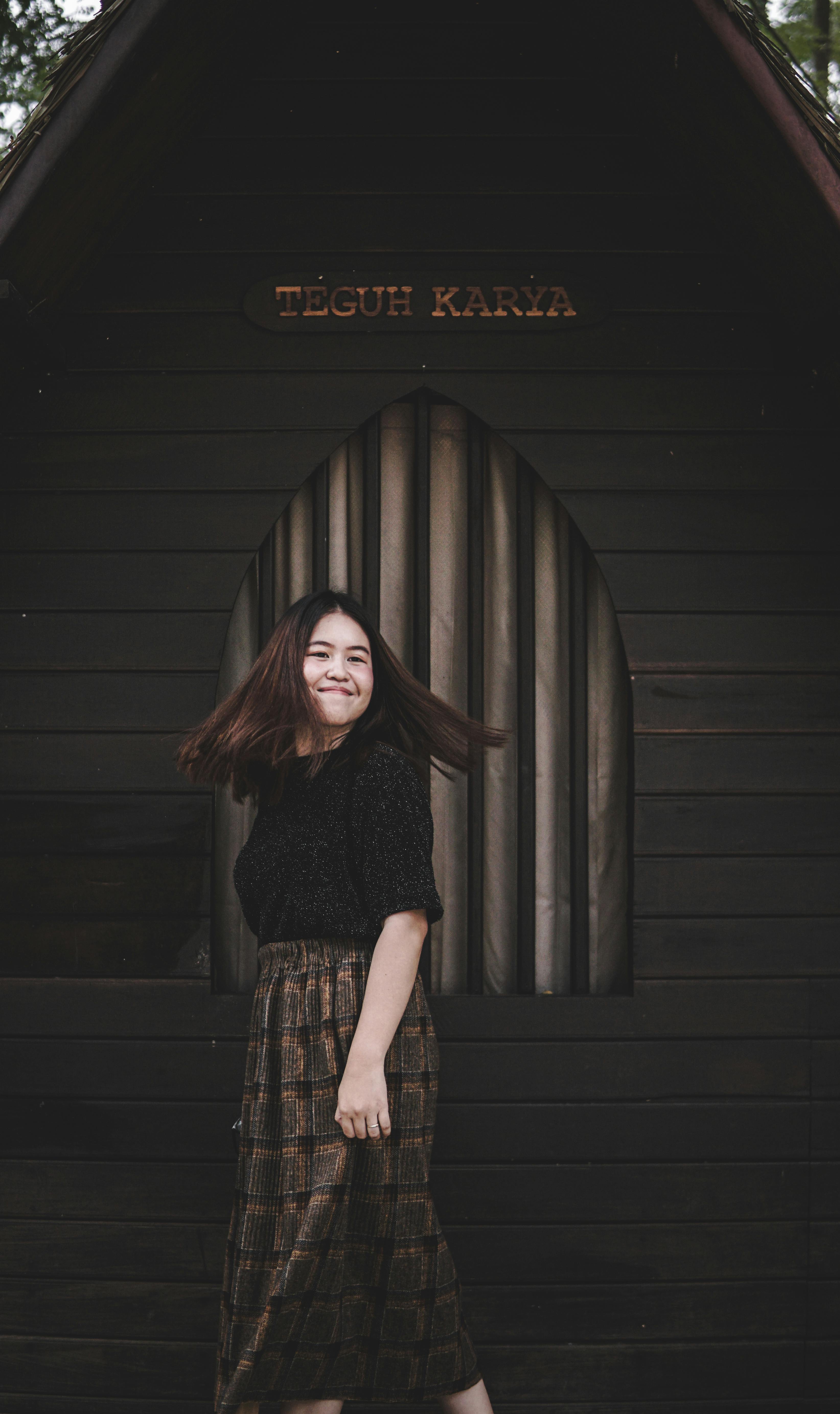Woman Smiling with a Hand Twirling her Hair · Free Stock Photo