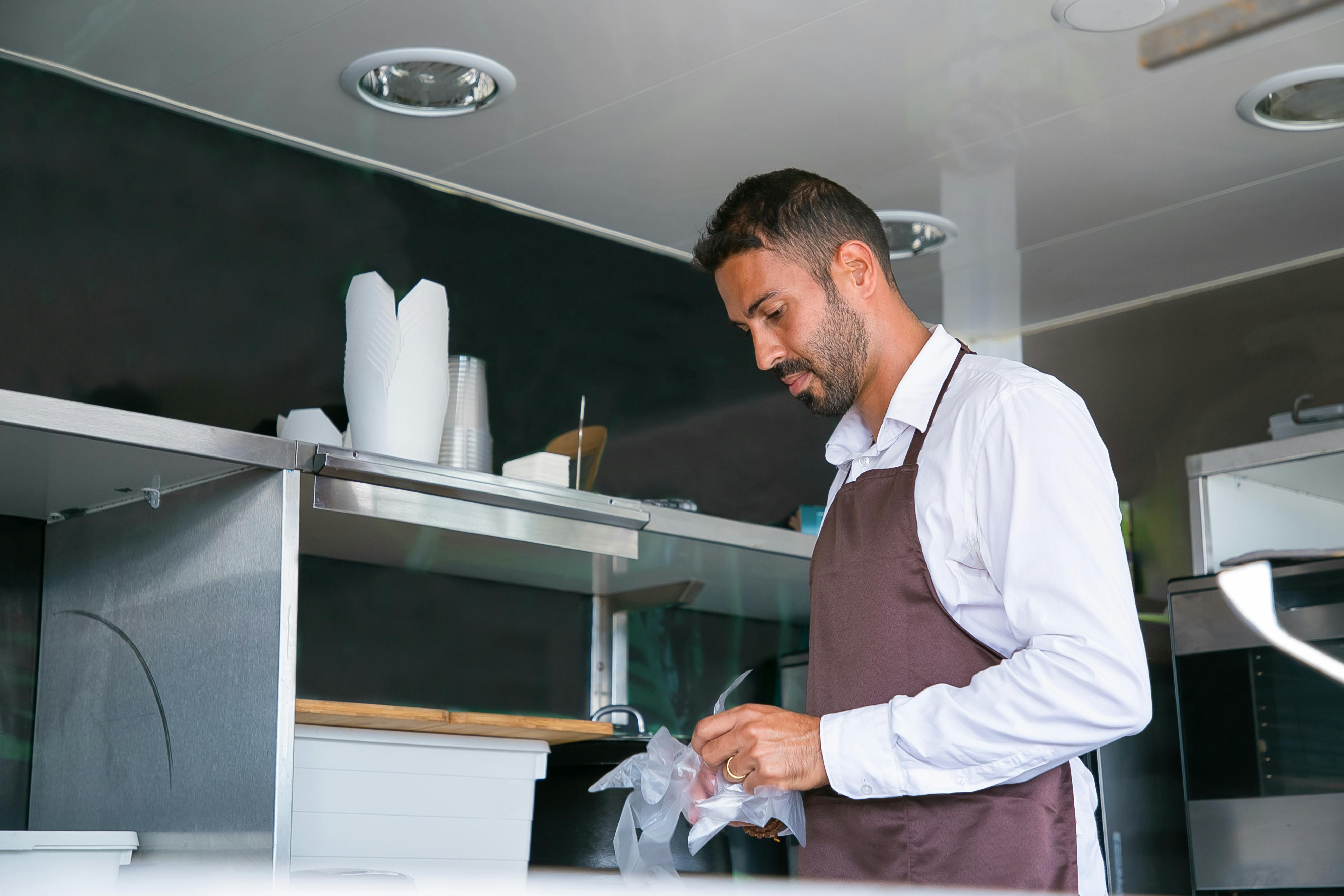 Chef Holding White Tea Cup · Free Stock Photo