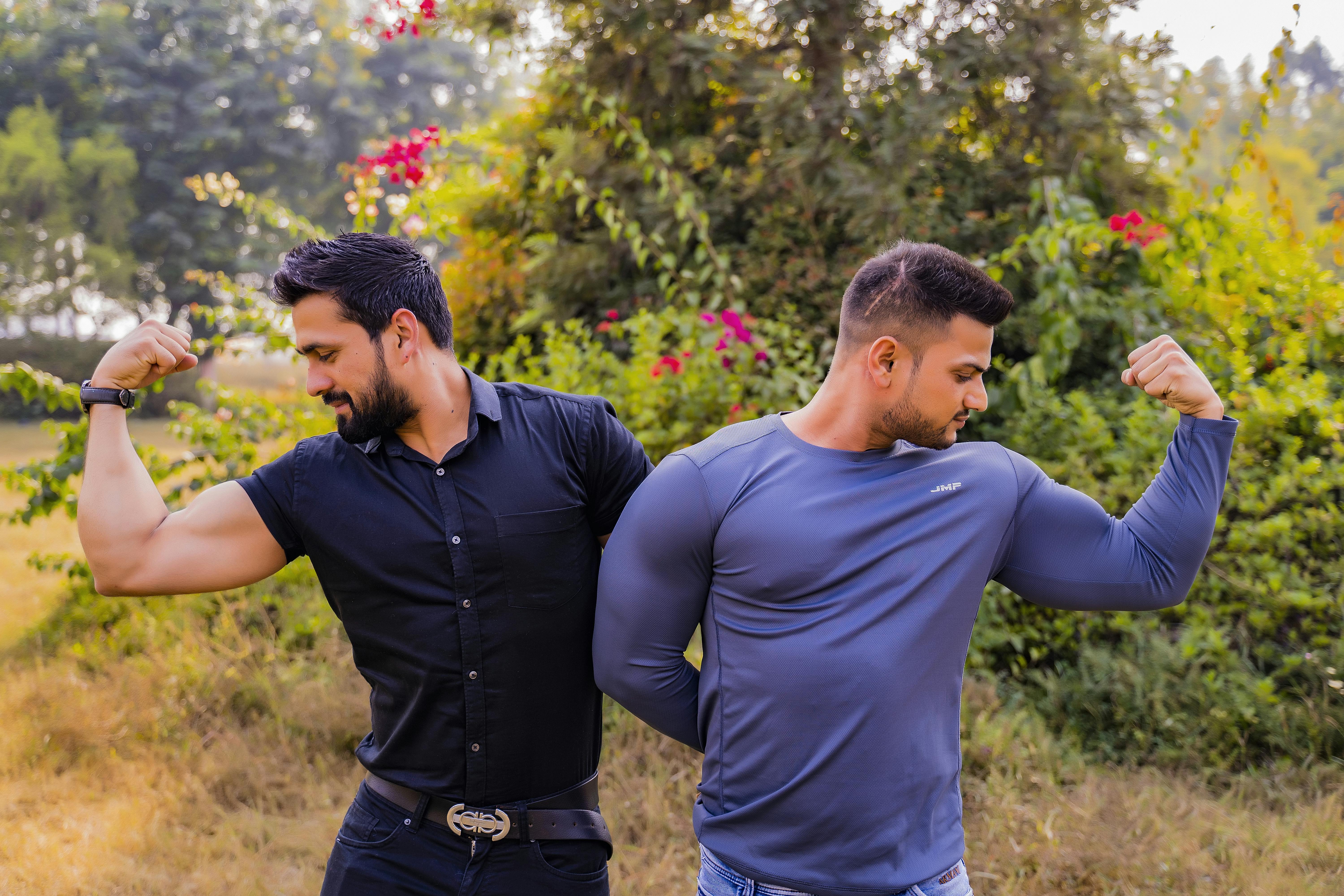 Two Muscular Men Flexing Their Biceps · Free Stock Photo