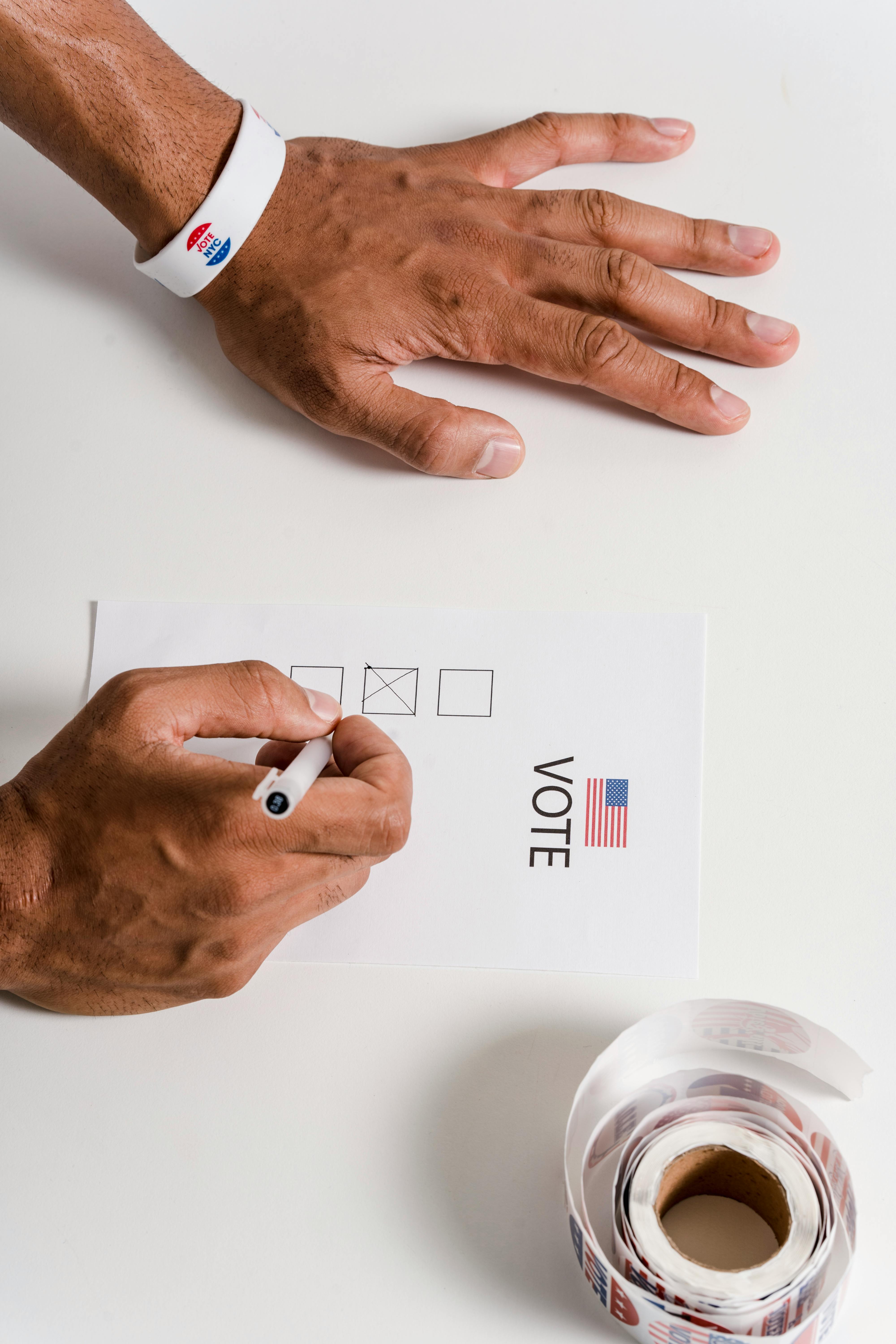 A Person Writing on White Paper · Free Stock Photo