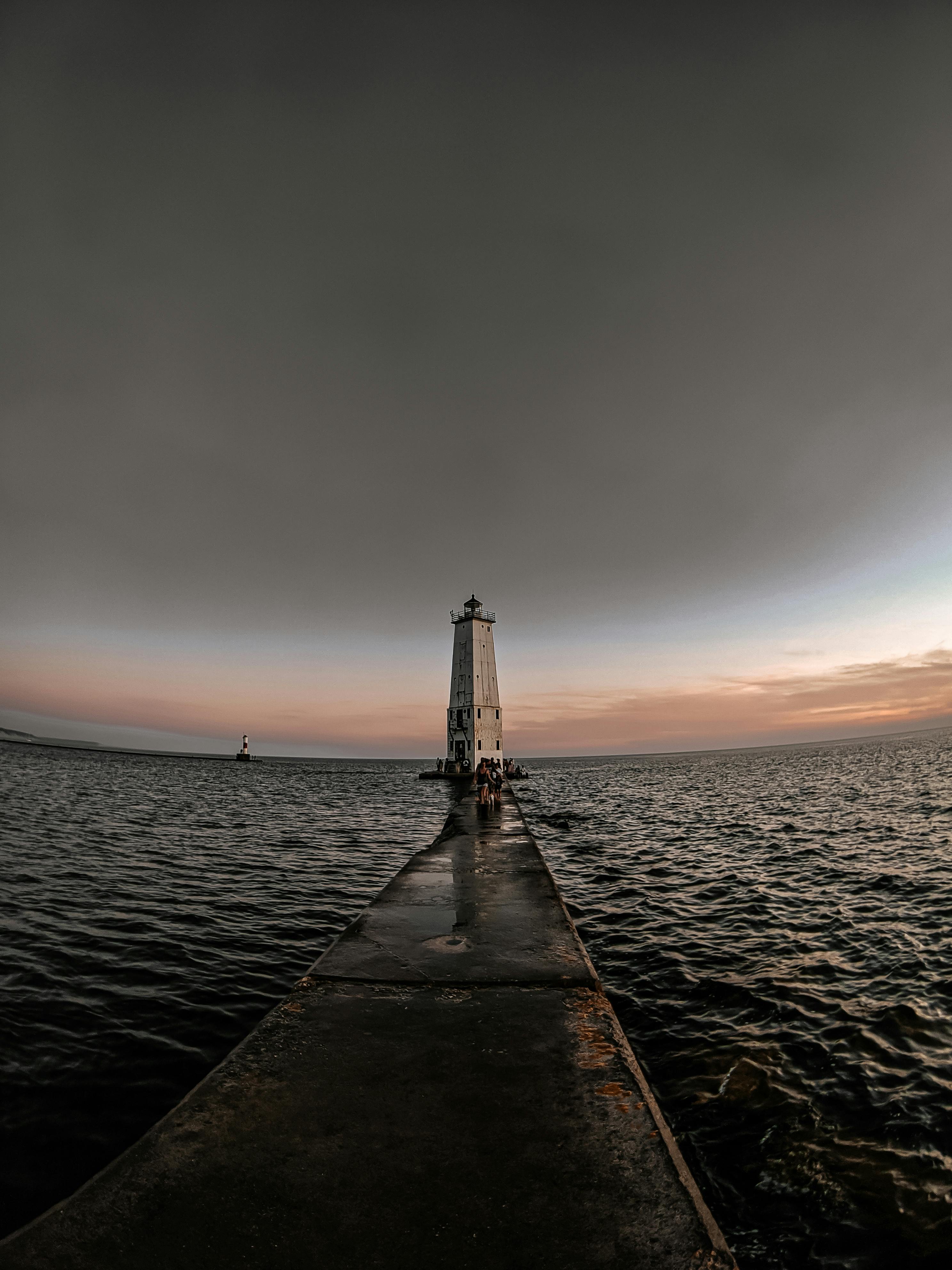 Photo of a Coast with a Lighthouse · Free Stock Photo