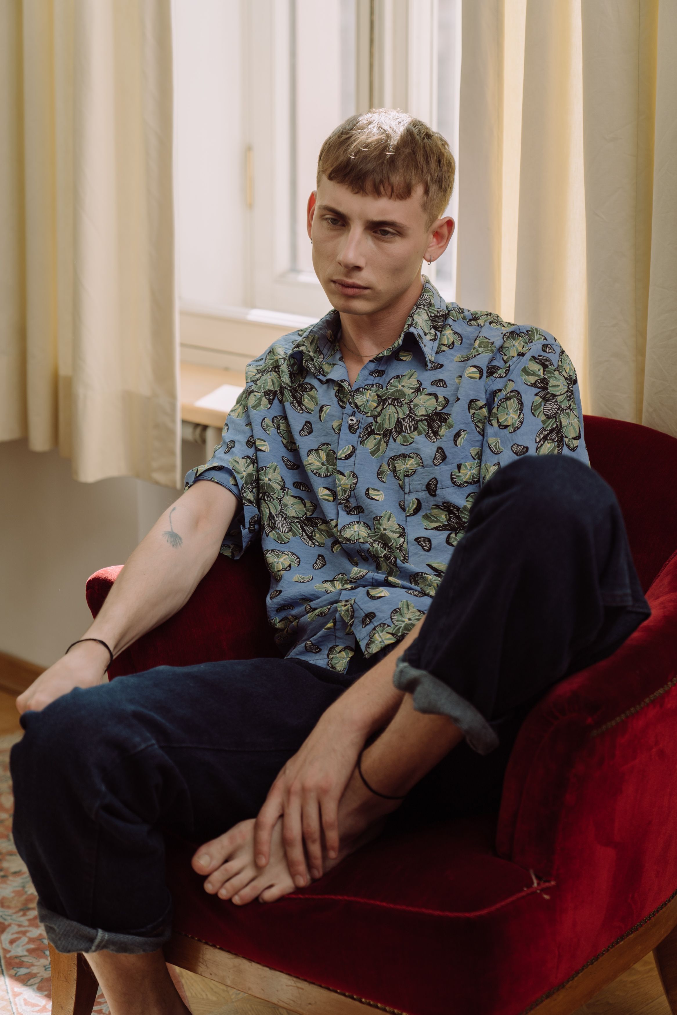 Man Sitting on Red Sofa Chair · Free Stock Photo