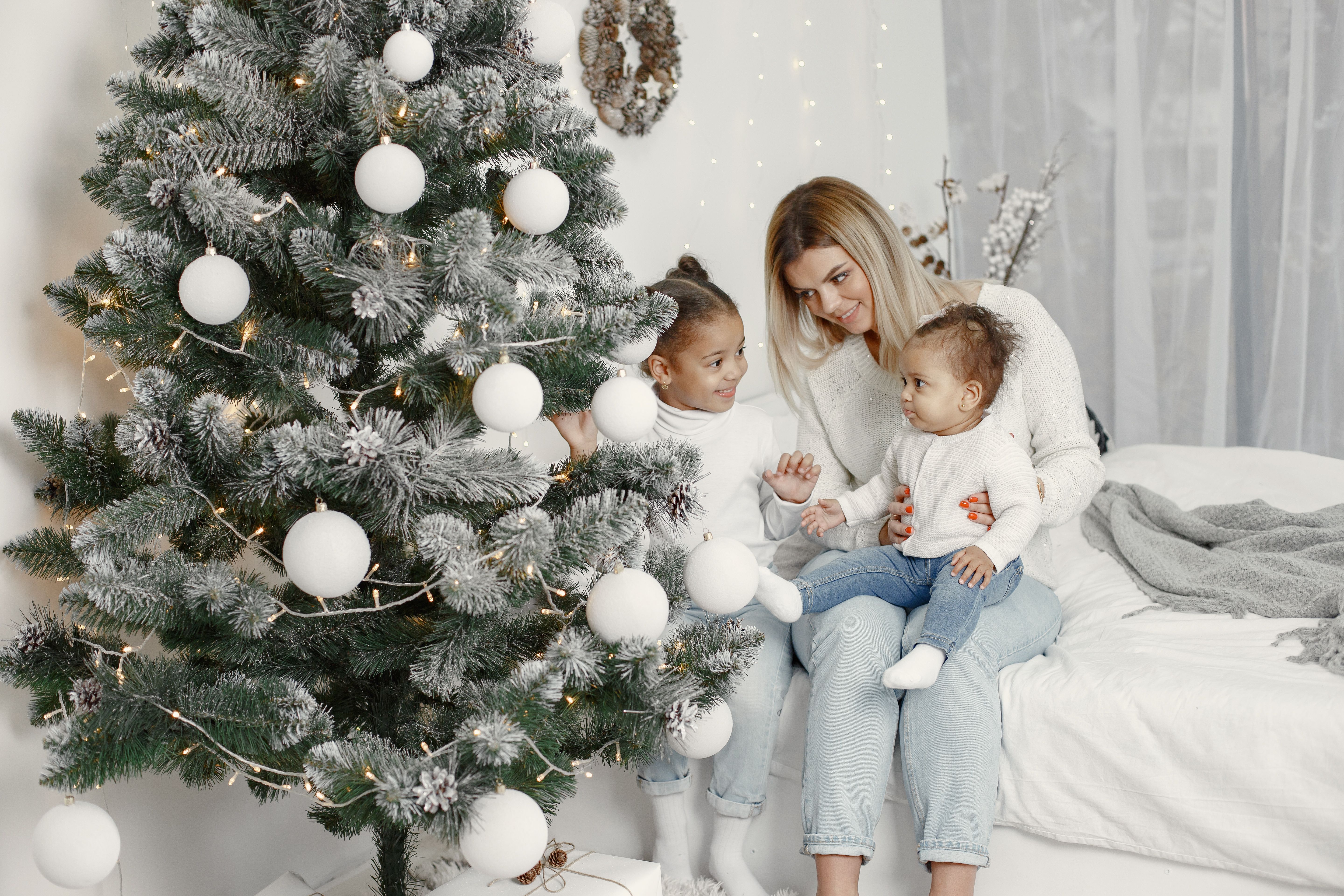 Woman with Two Children Sitting by the Christmas Tree · Free Stock Photo