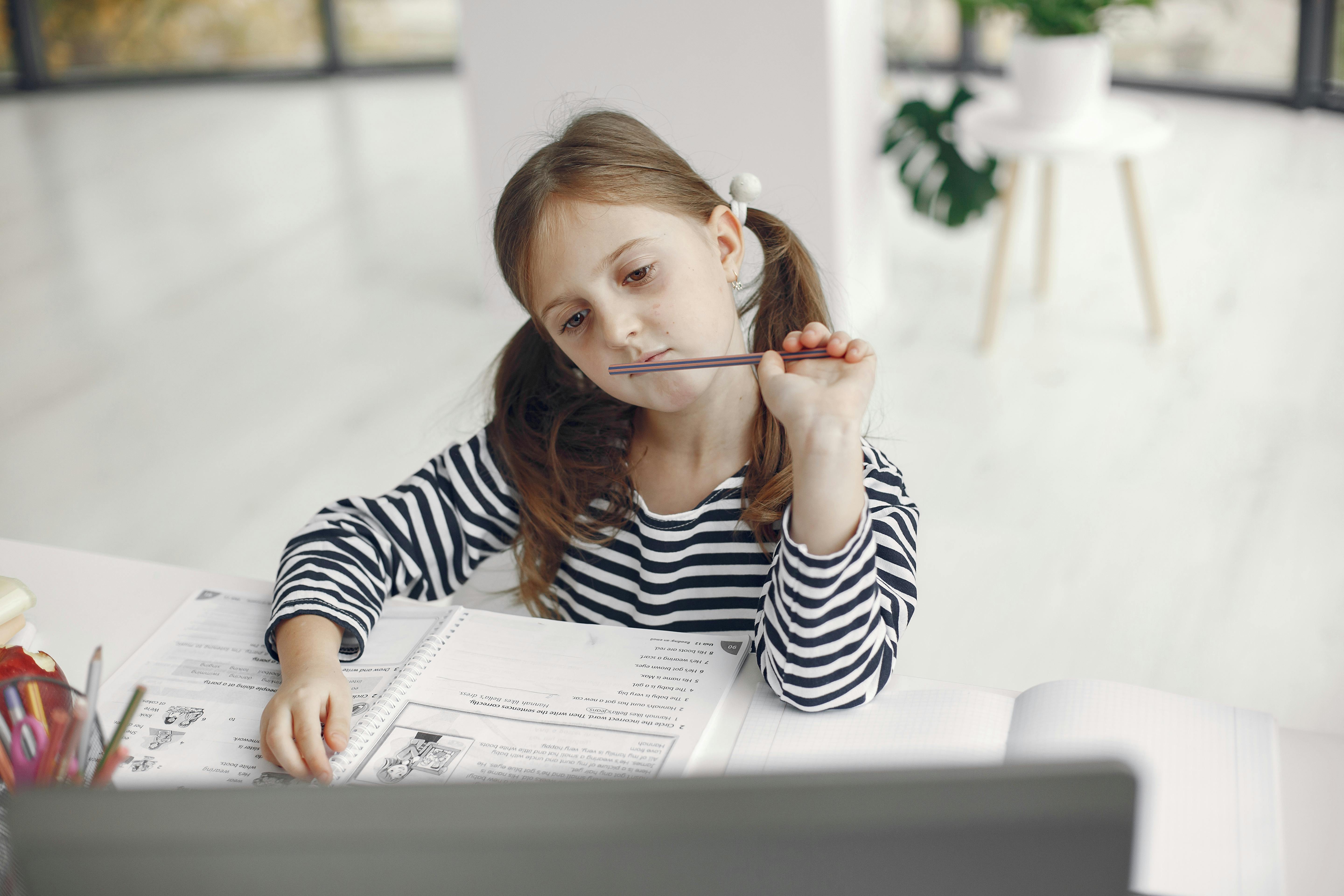 Girl Doing her Homework at Home · Free Stock Photo