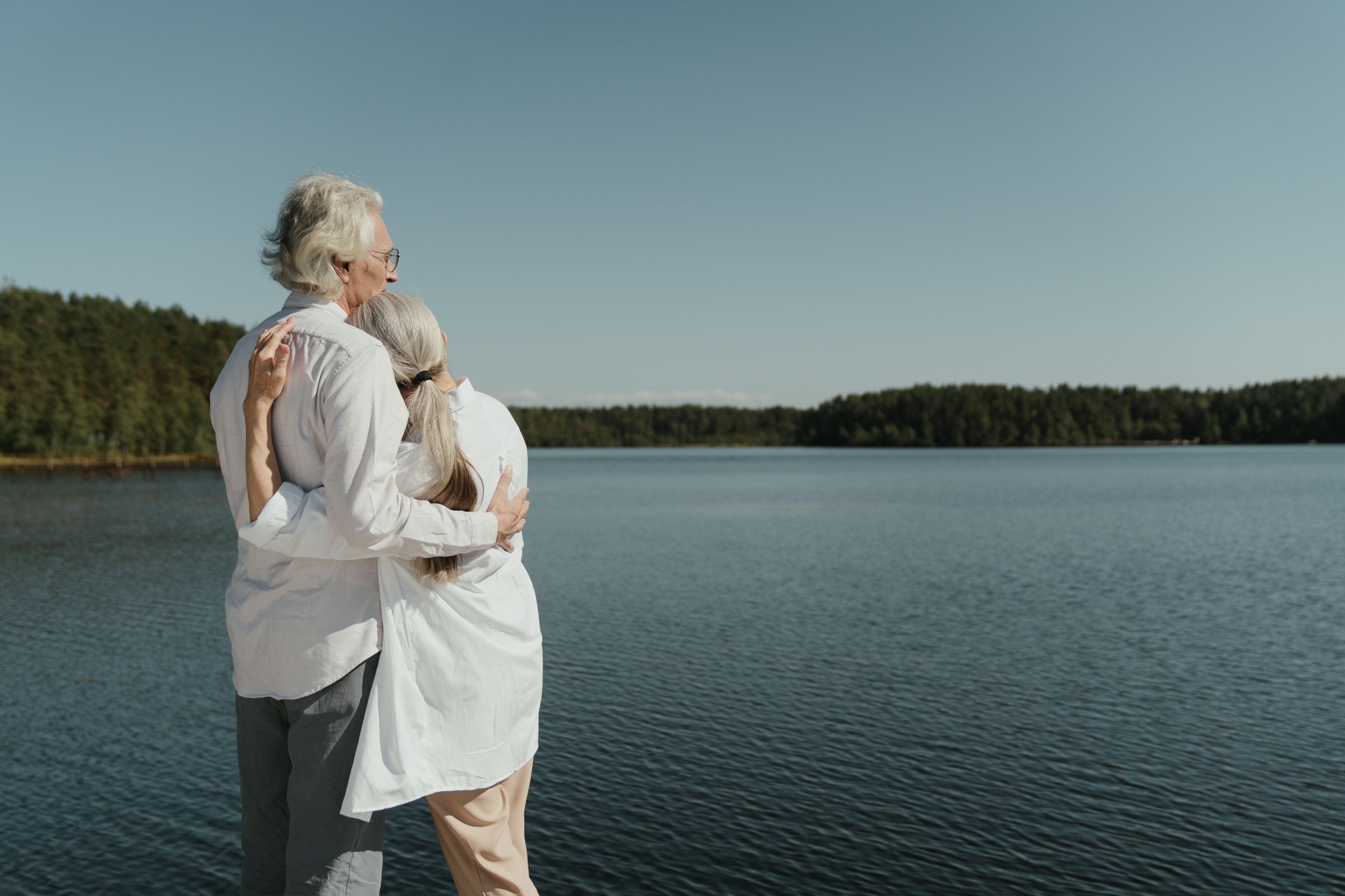 An Elderly Couple Hugging near the Lake · Free Stock Photo