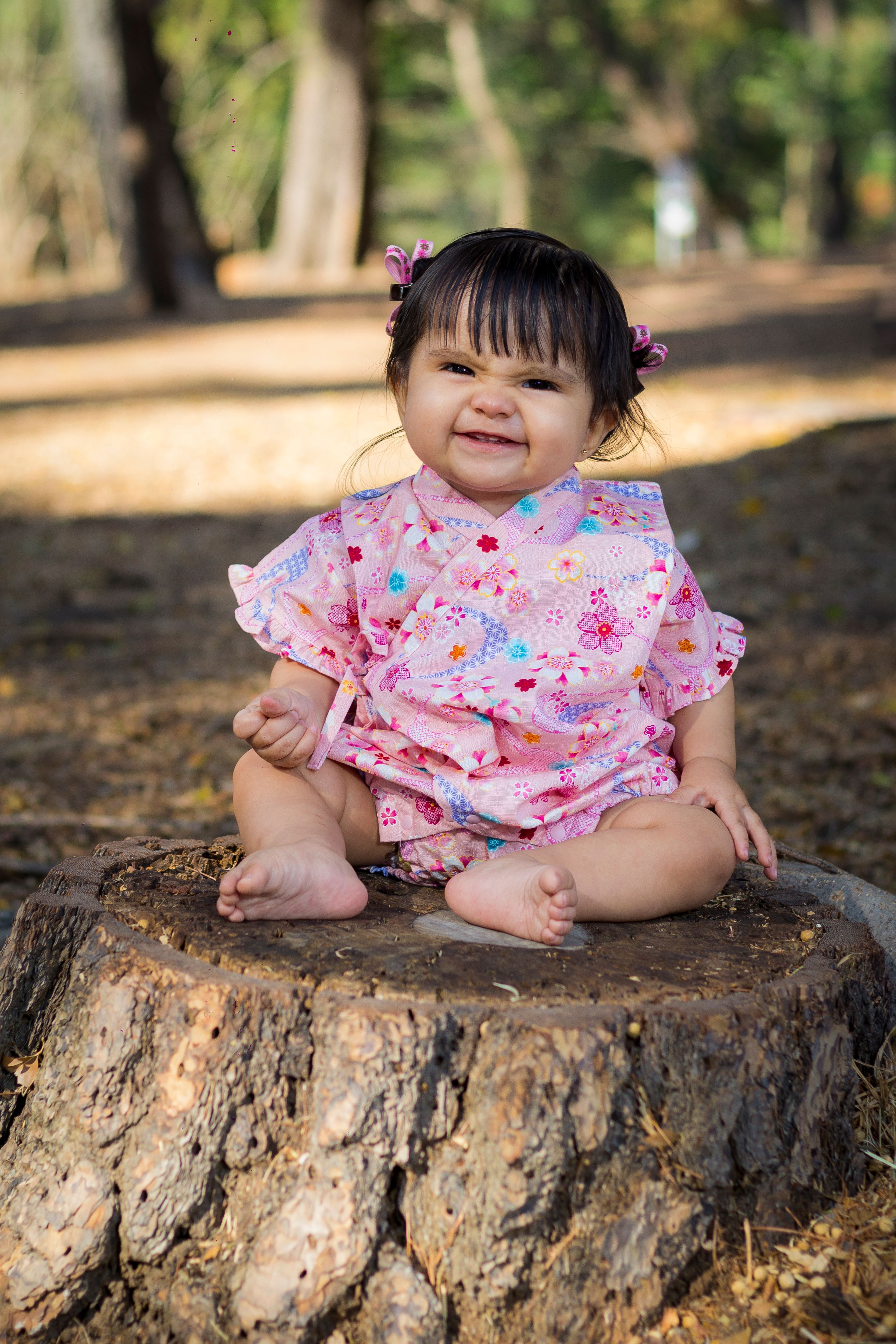 Little Girl Sitting on a Log · Free Stock Photo