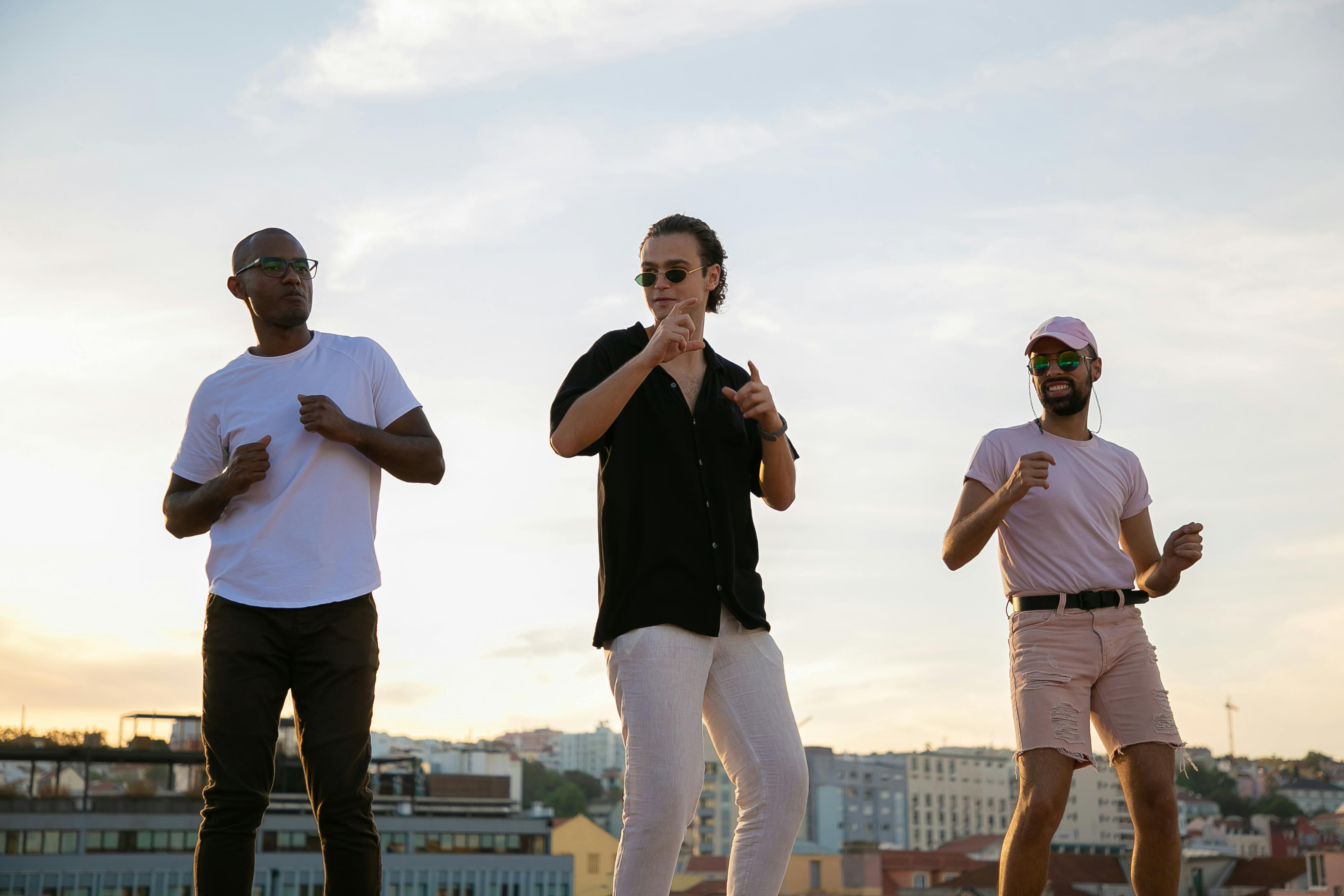 Anonymous girlfriends dancing against sunset sky · Free Stock Photo