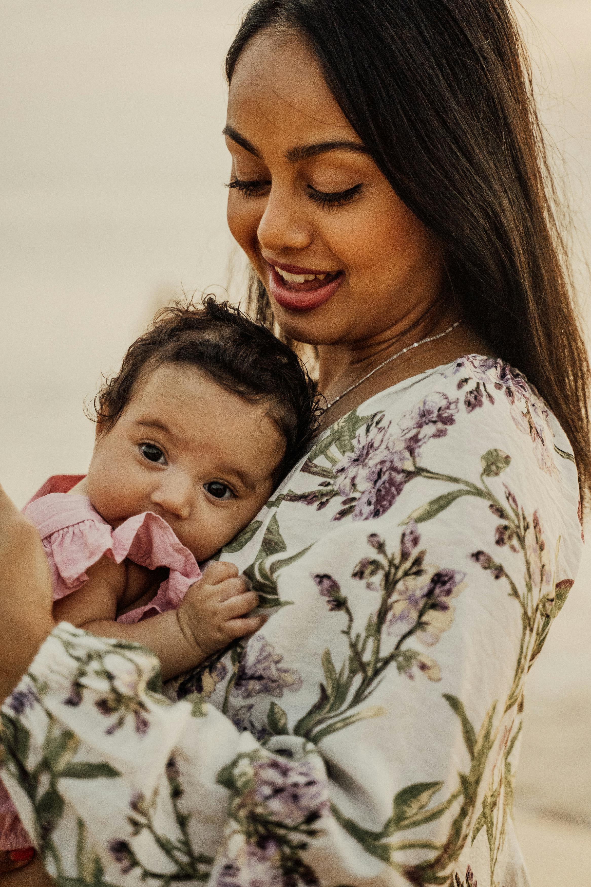 A Woman Carrying her Child · Free Stock Photo