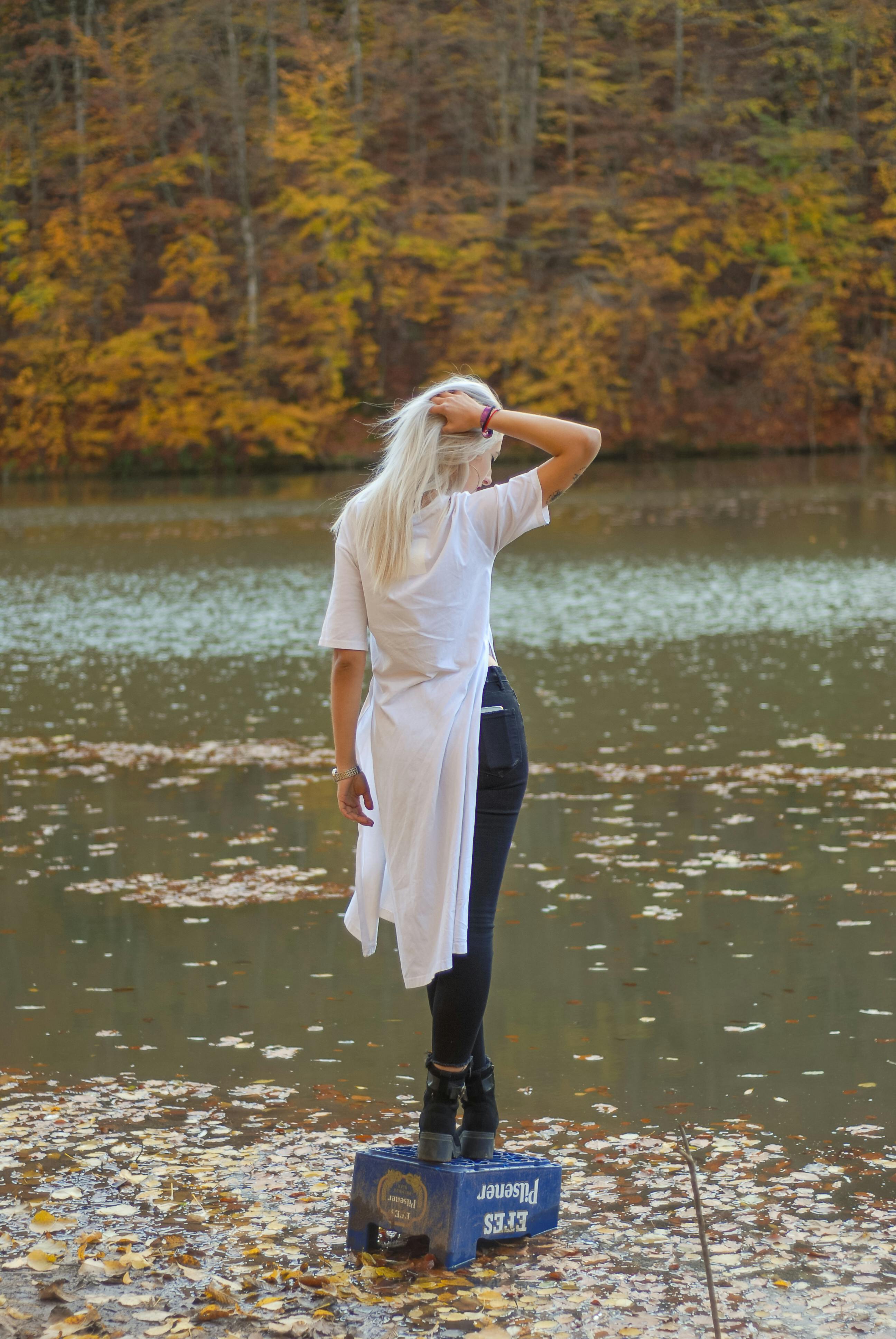 Woman Standing on Box on Lake · Free Stock Photo