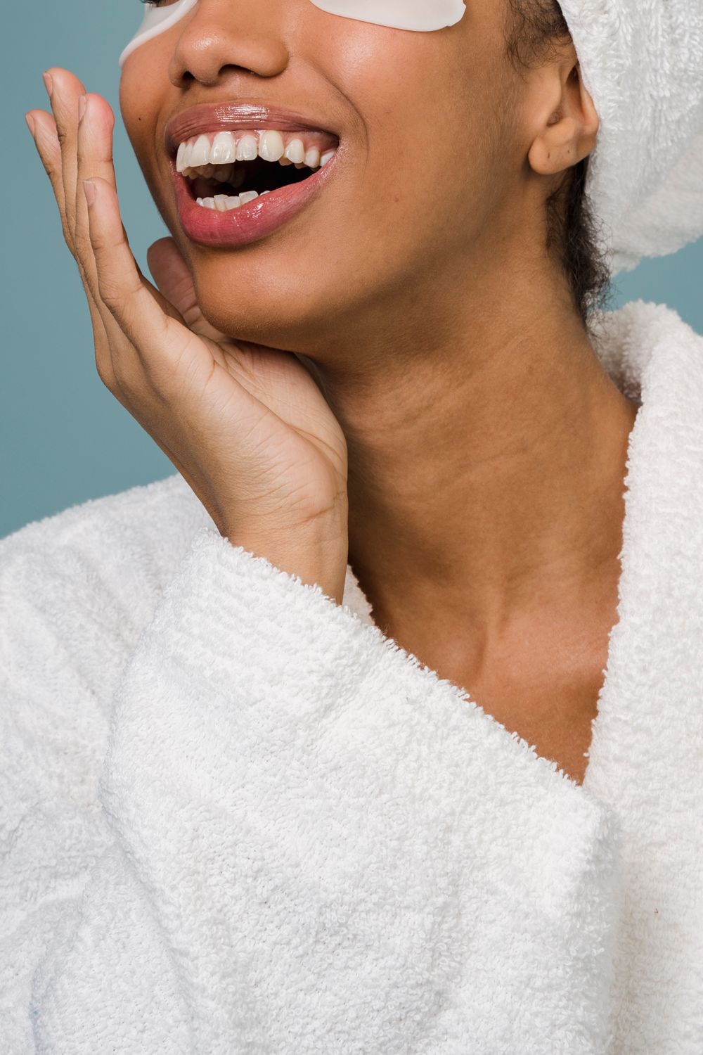 Delighted African American Woman Laughing During Skin Care Routine Delighted African American Woman Laughing During Skin Care Routine