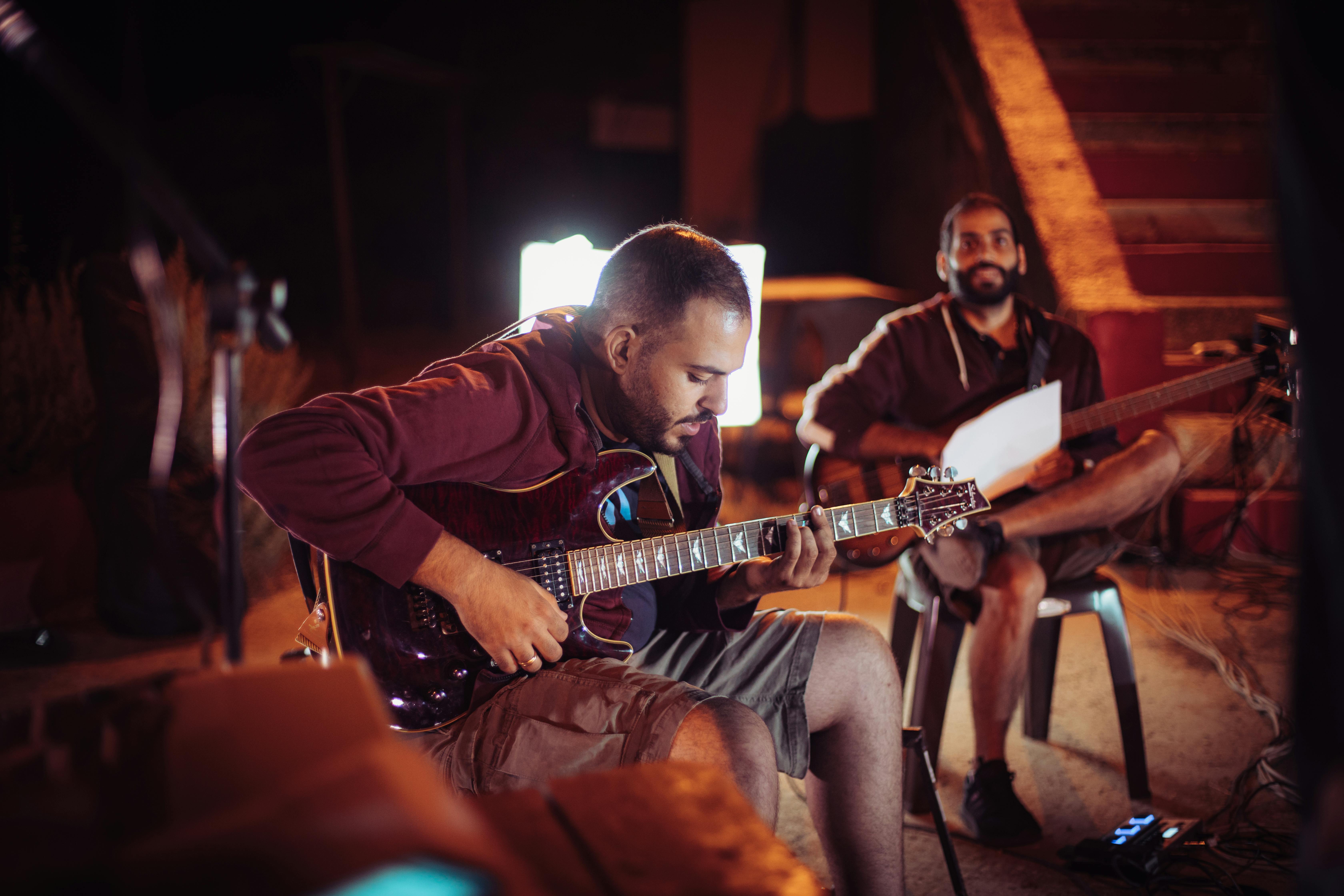 Men Playing Guitars in a Band · Free Stock Photo
